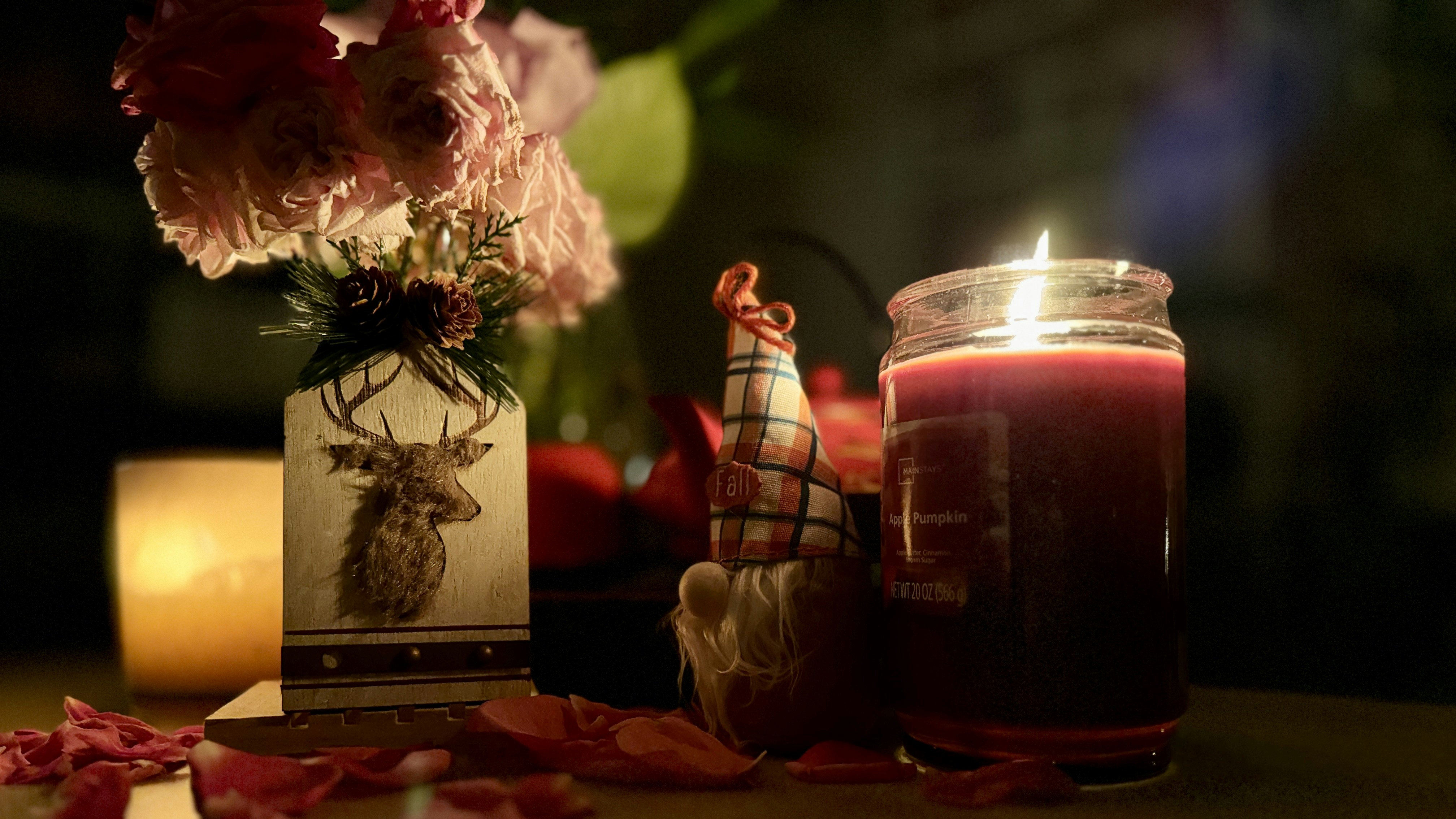 a candle and some flowers on a table