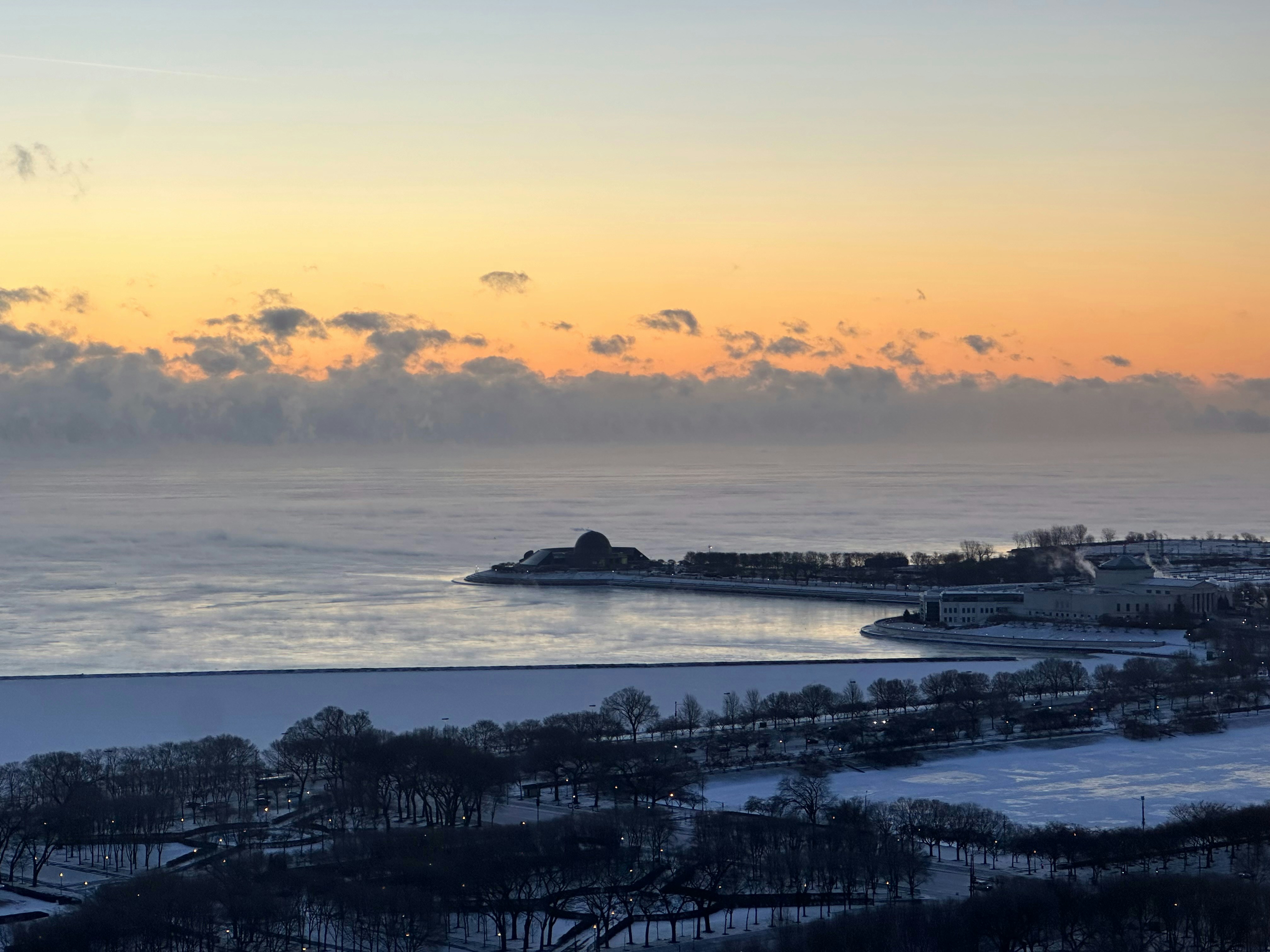 Adler Planetarium below 0 sunrise. | a view of the ocean from a high point of view