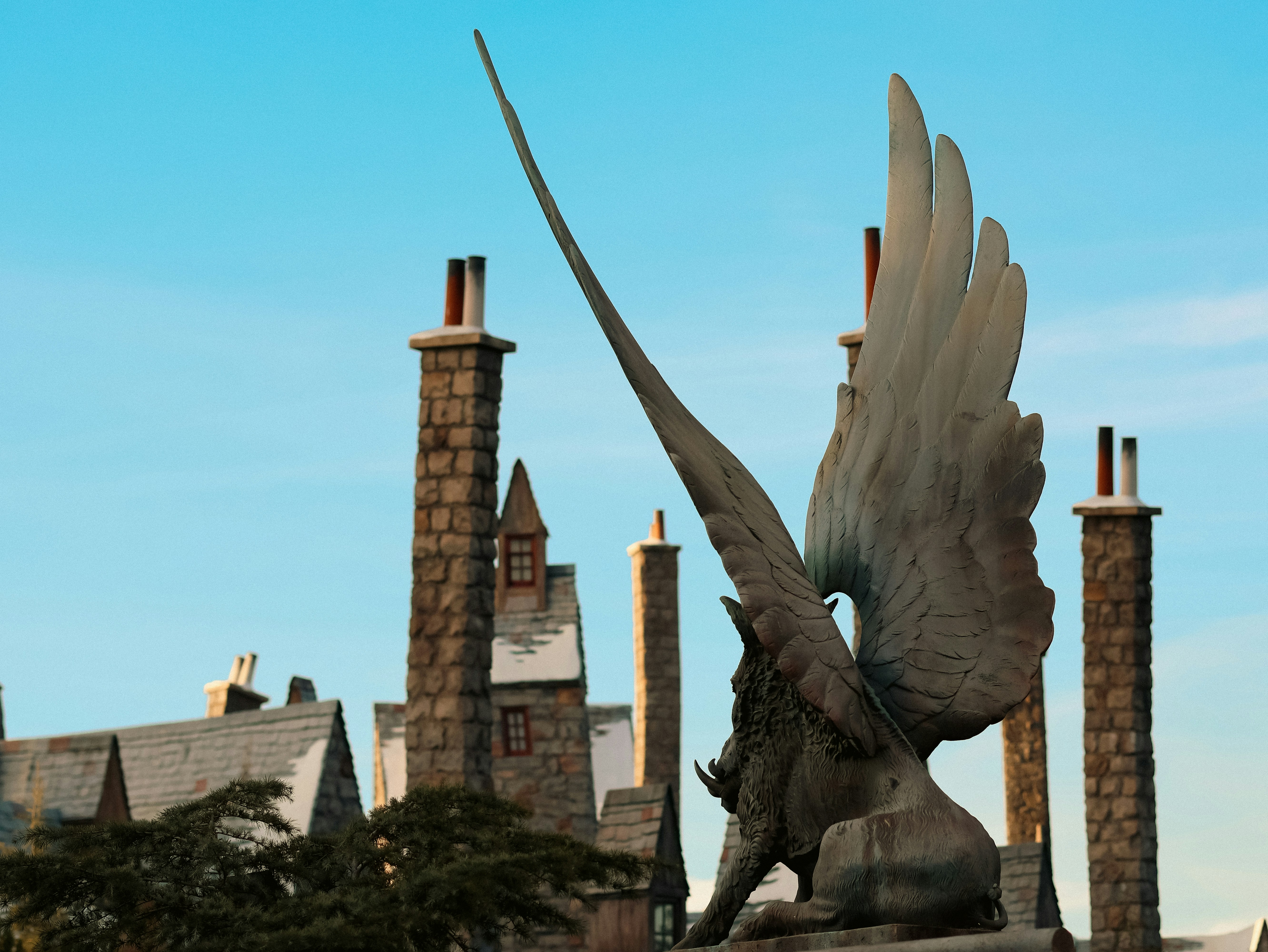 A statue of a winged bird on top of a building photo – Free Hogwarts ...