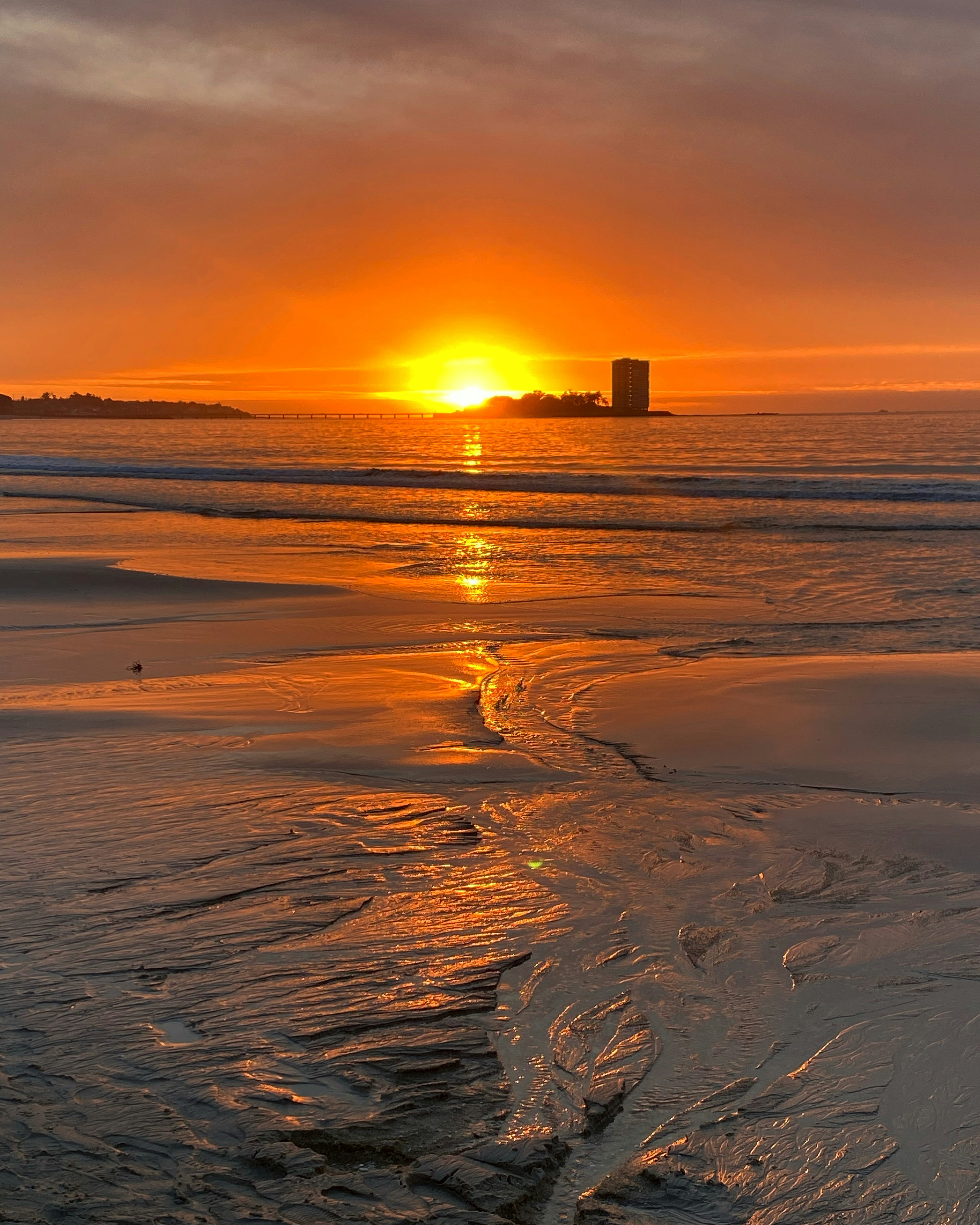 Horizon Ember over Rippled Sand: Sunset at the Quiet Shore