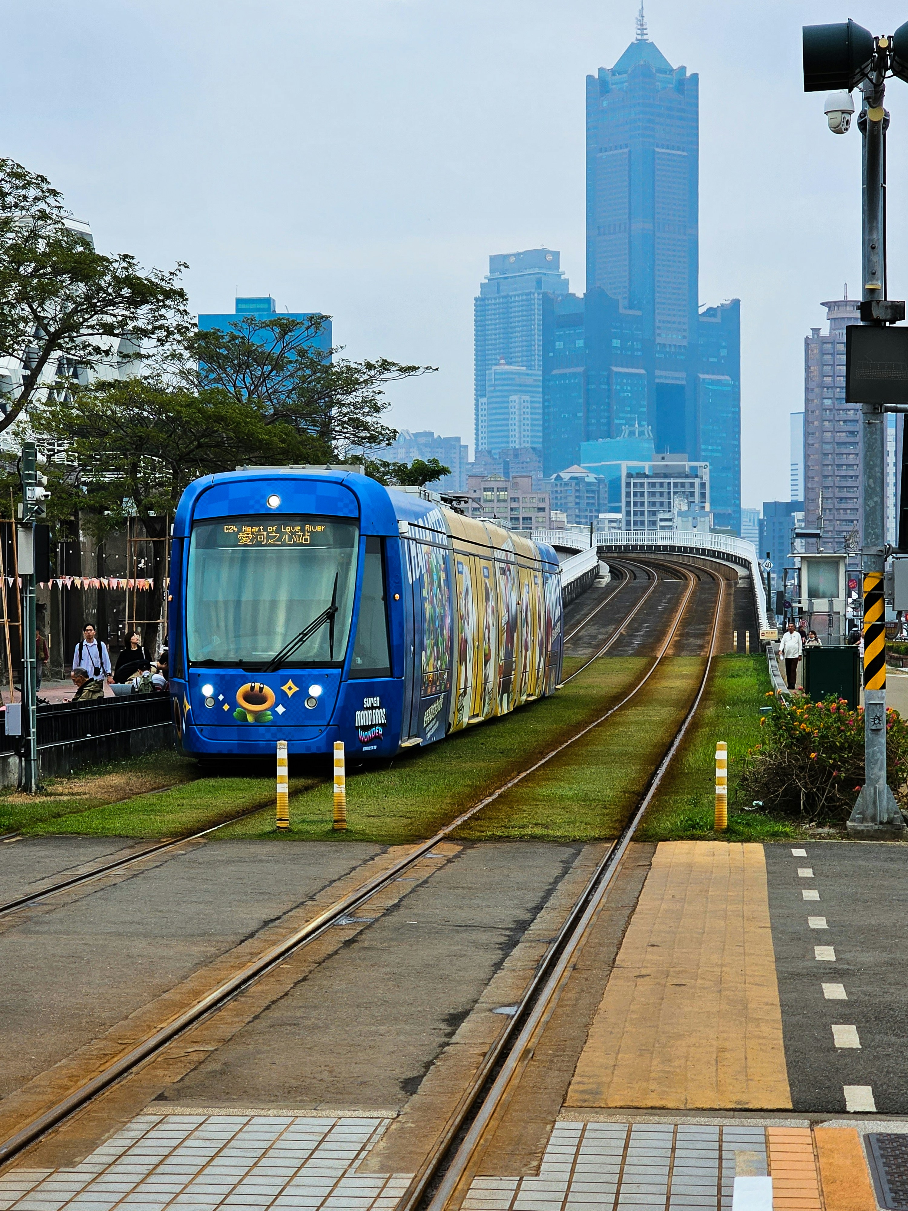 Blue Commuter Express Winding Toward a Steel Jungle Skyline