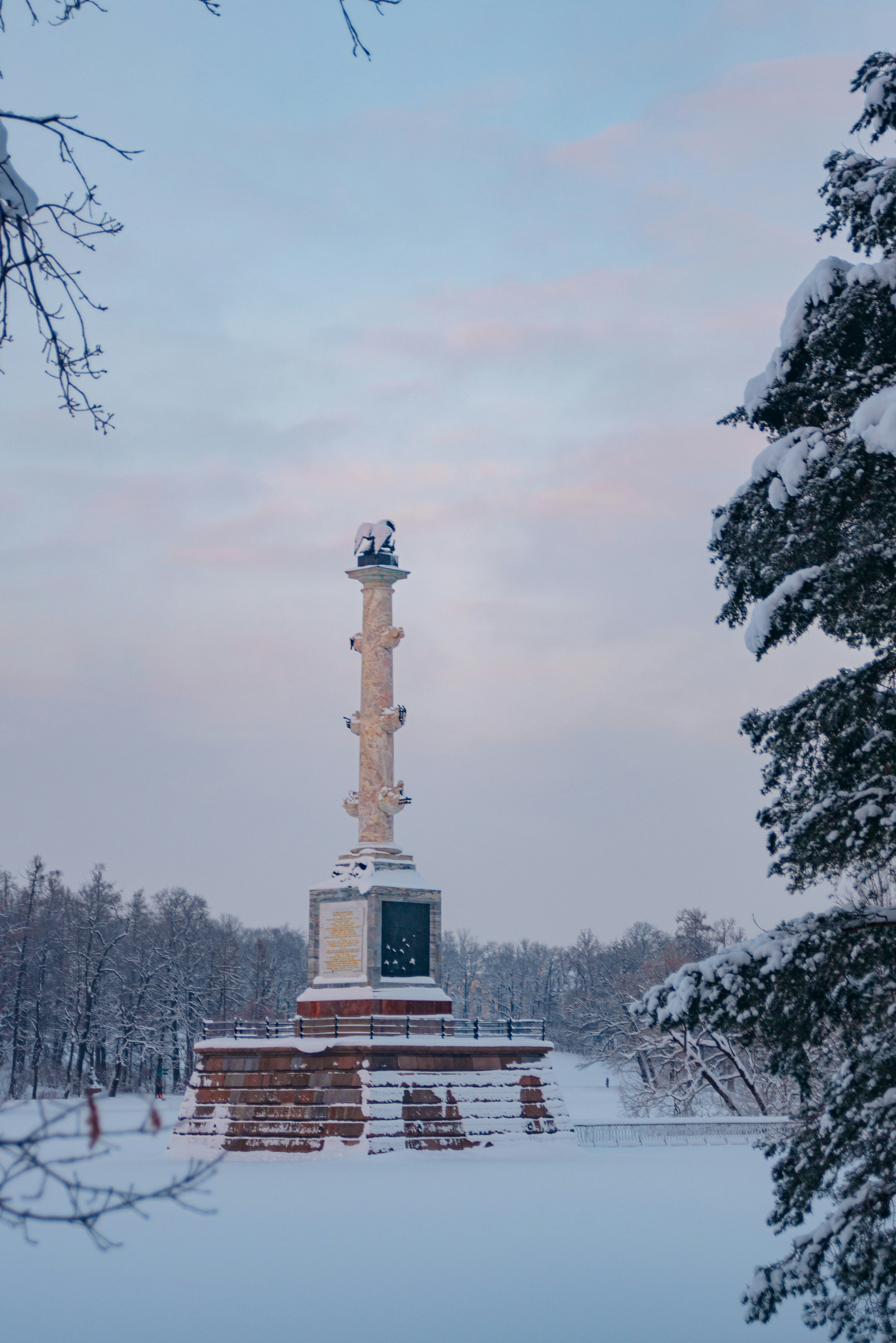Snow Veiled Obelisk Framing a Pink Winter Dawn
