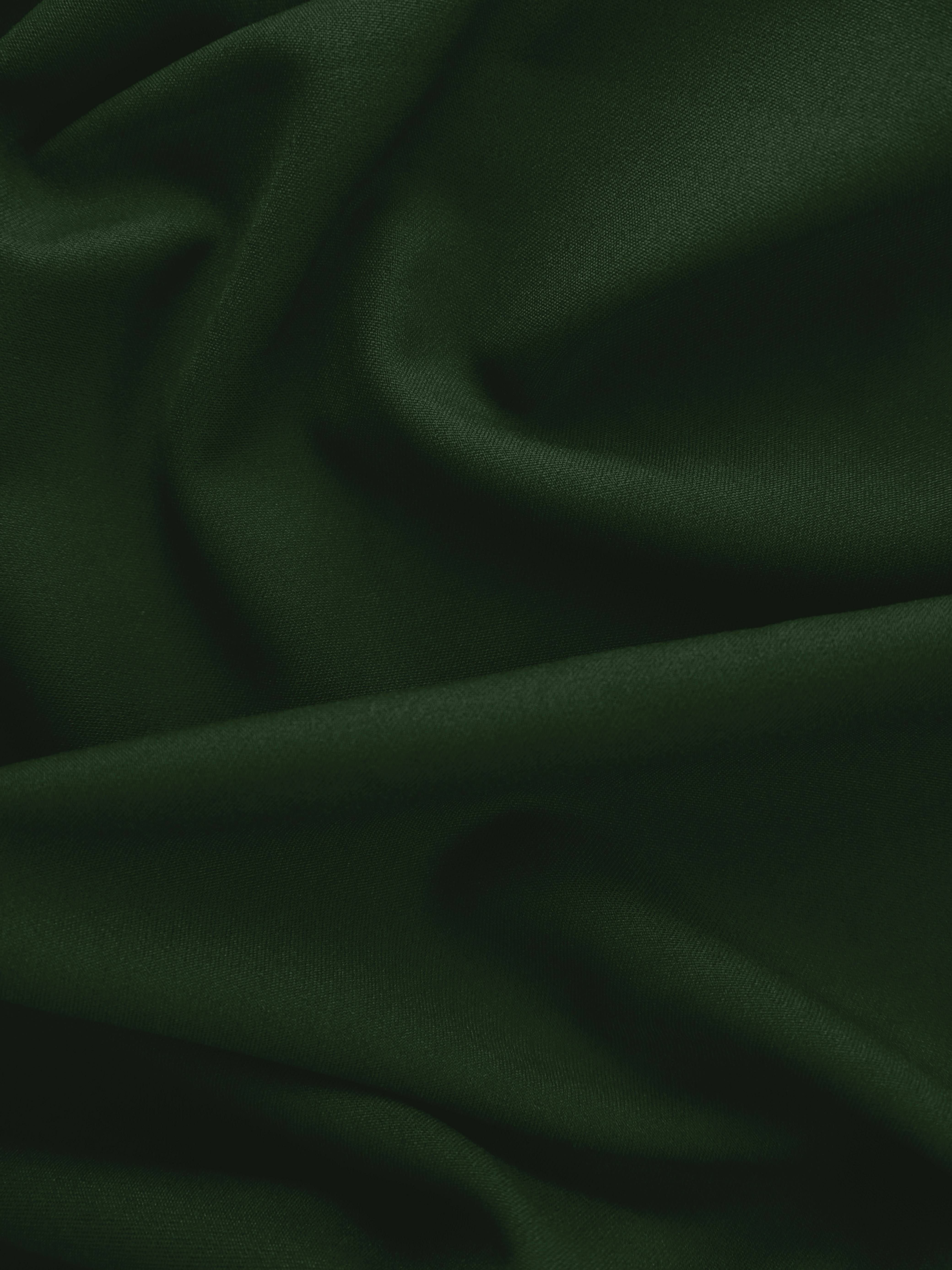 A close up of a dark green fabric photo – Free Green Image on Unsplash