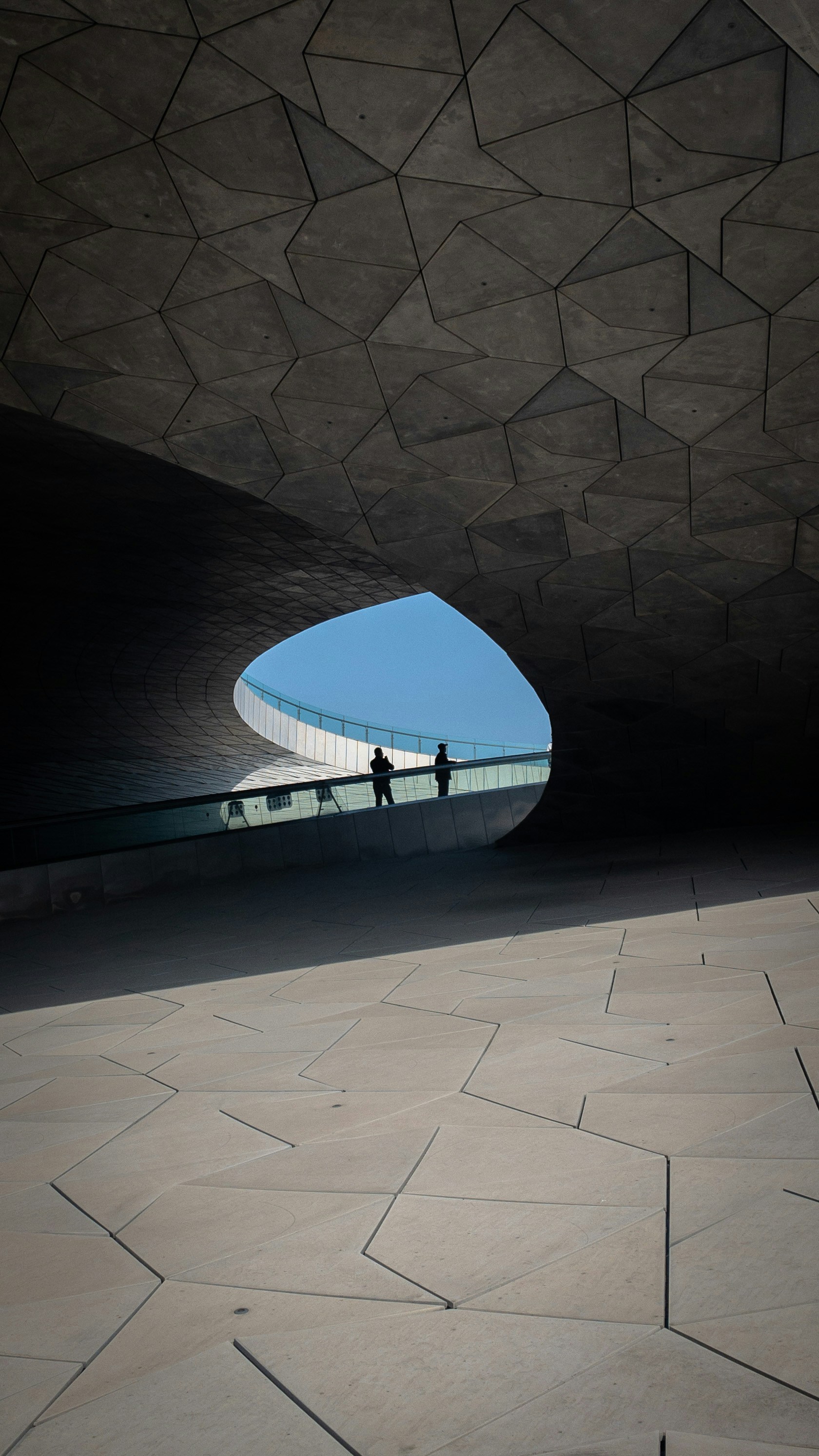 A couple of people that are standing under a building photo – Free Path ...