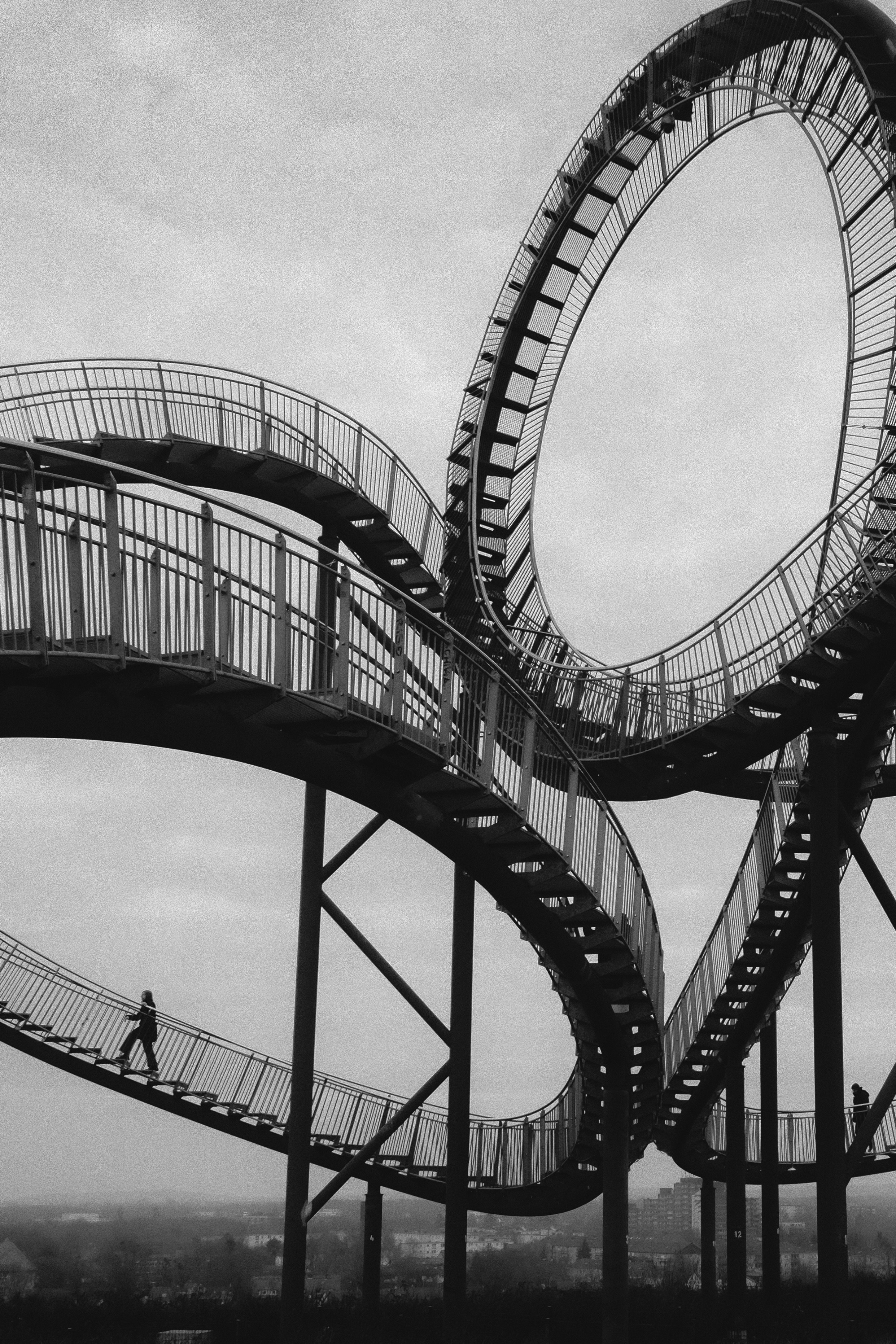 A man is walking across a roller coaster photo – Free Human Image on ...