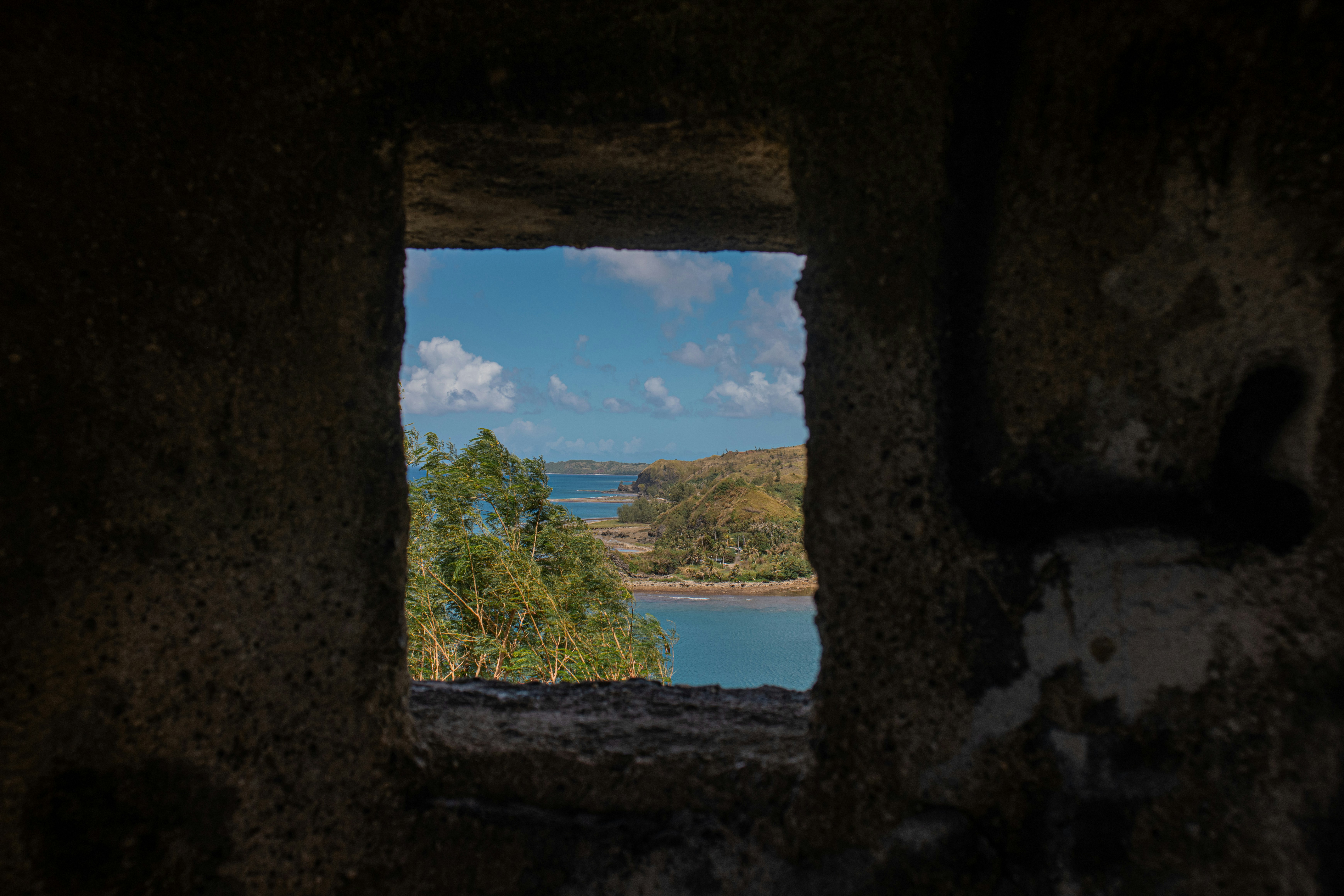 A view of a lake through a hole in a wall photo – Free Guam Image on ...