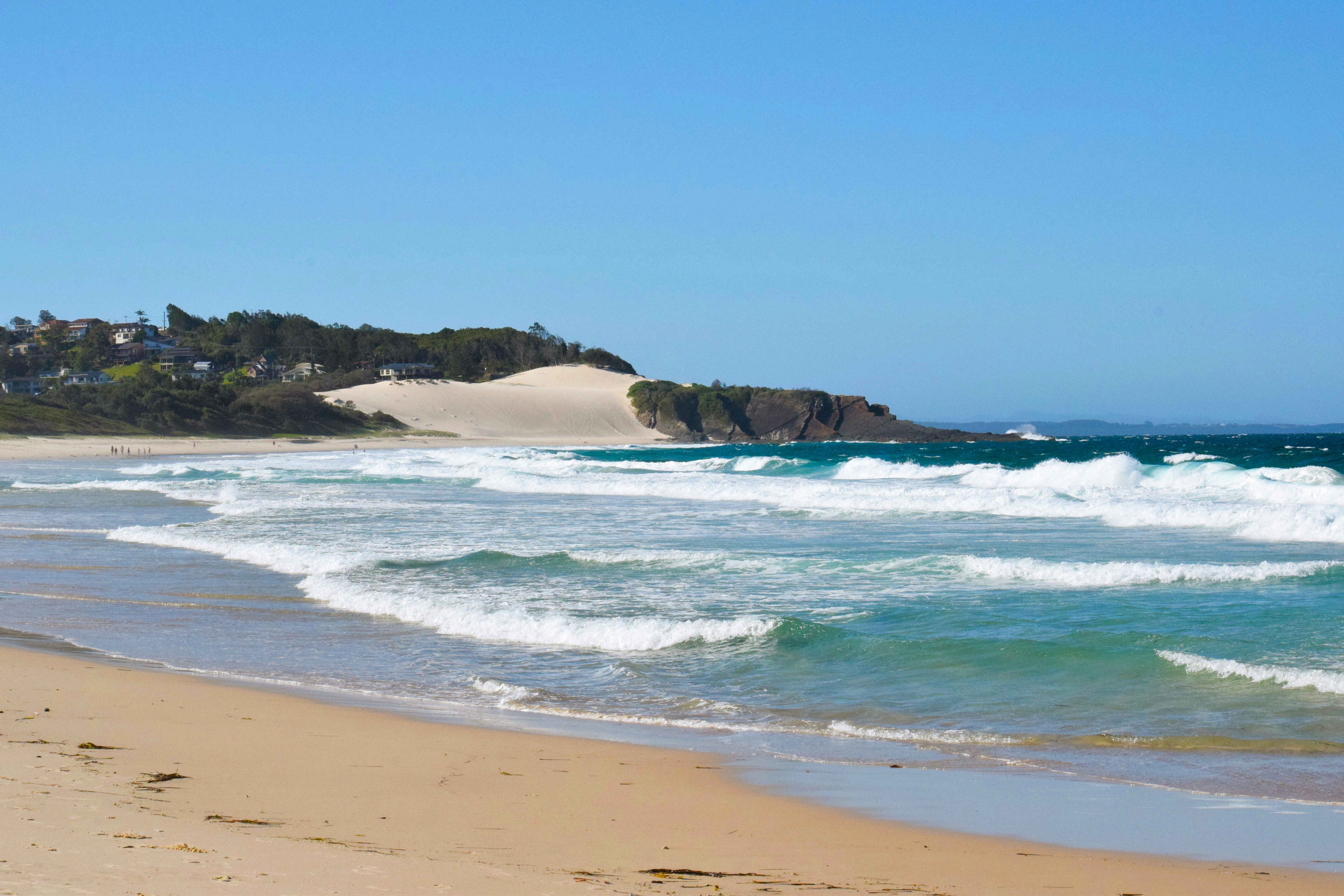A sandy beach with waves coming in to shore photo – Free Forster nsw ...