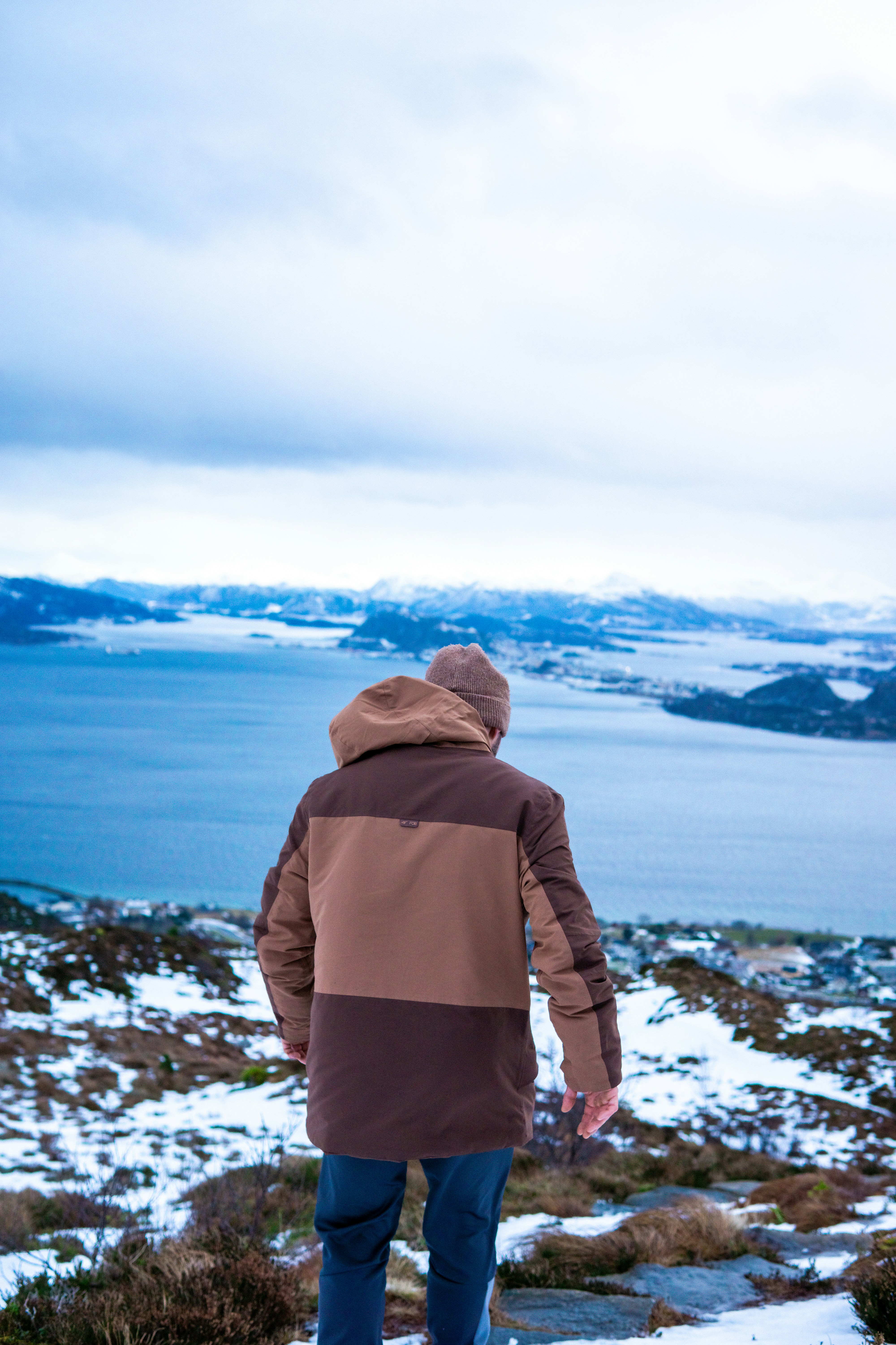 Horizon Gaze: A Climber Pauses at the Edge of Snow and Sea