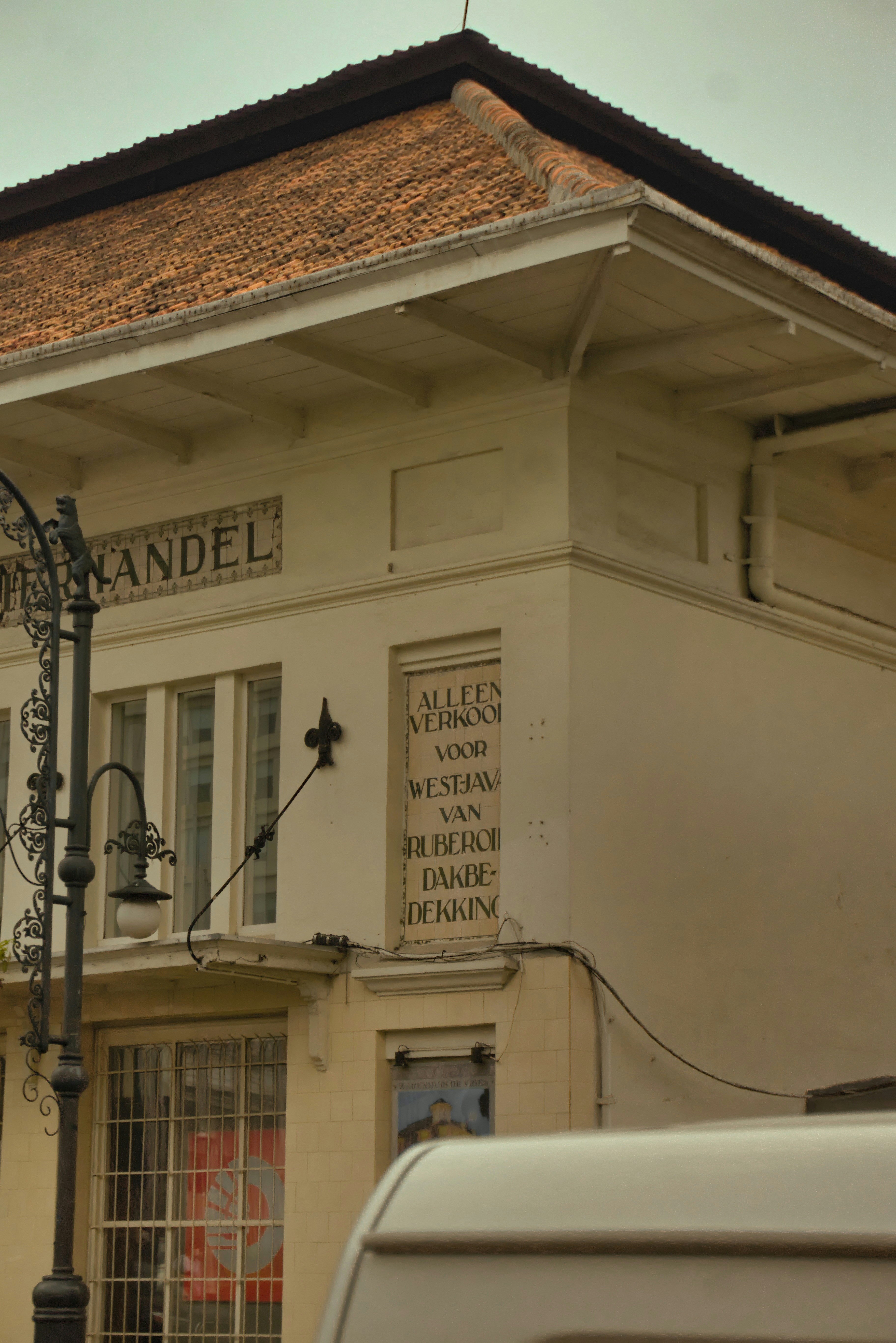 Weathered Facade at a Quiet Street Corner with Wrought-Iron Lantern