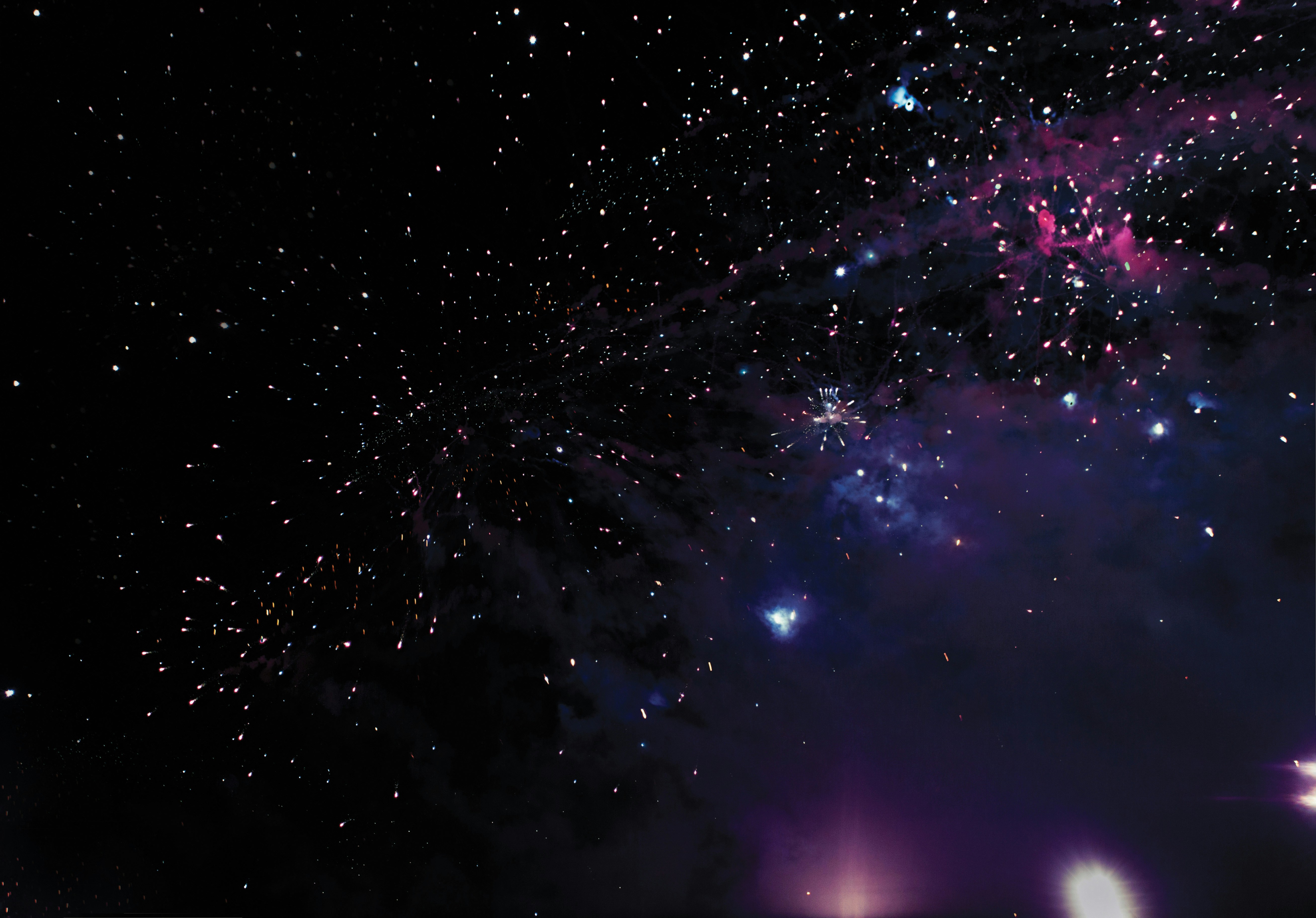 Cosmic Confetti: Fireworks of the Nebula over a Night Sky