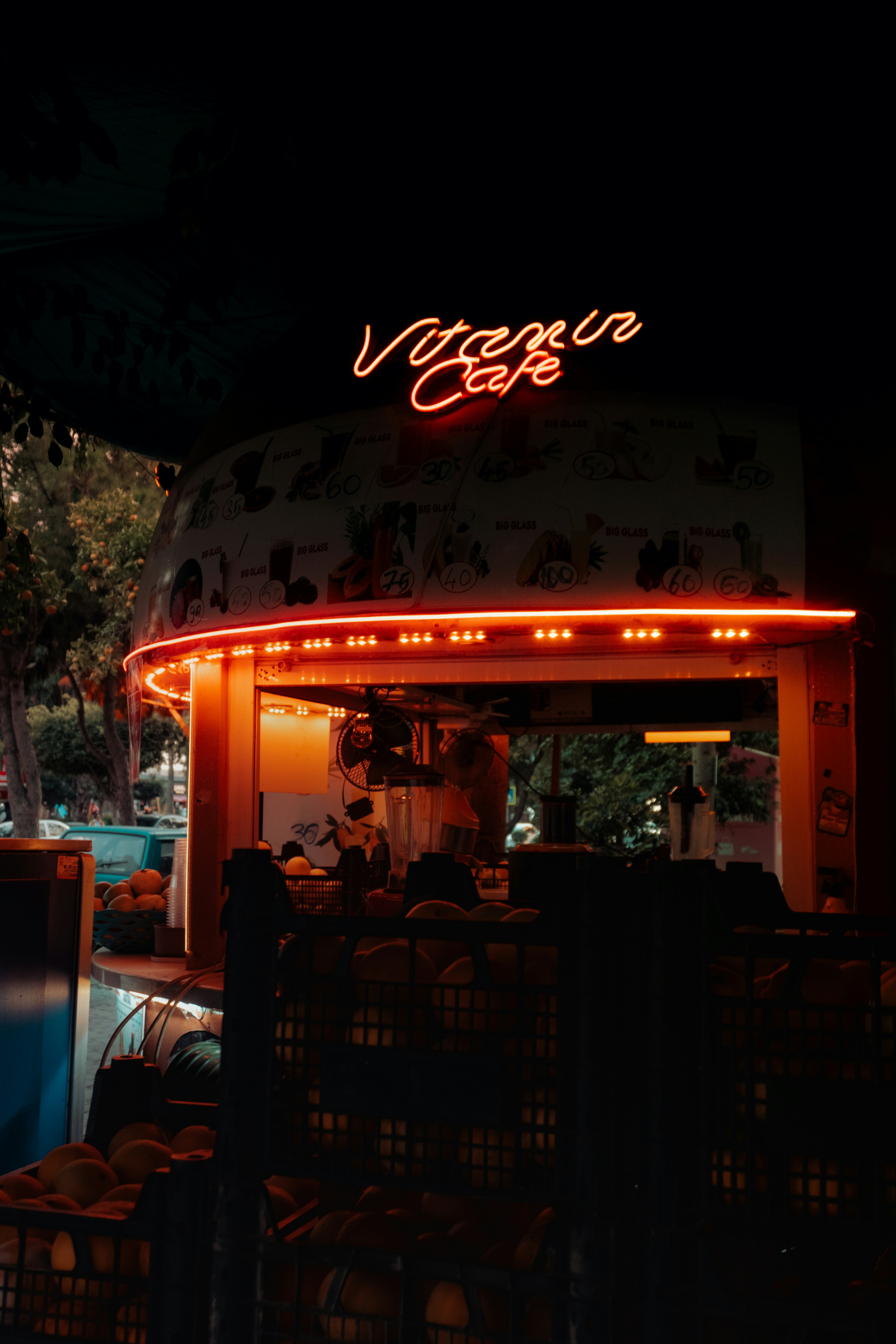 Amber Neon Halo Over a Dusk Café Stand