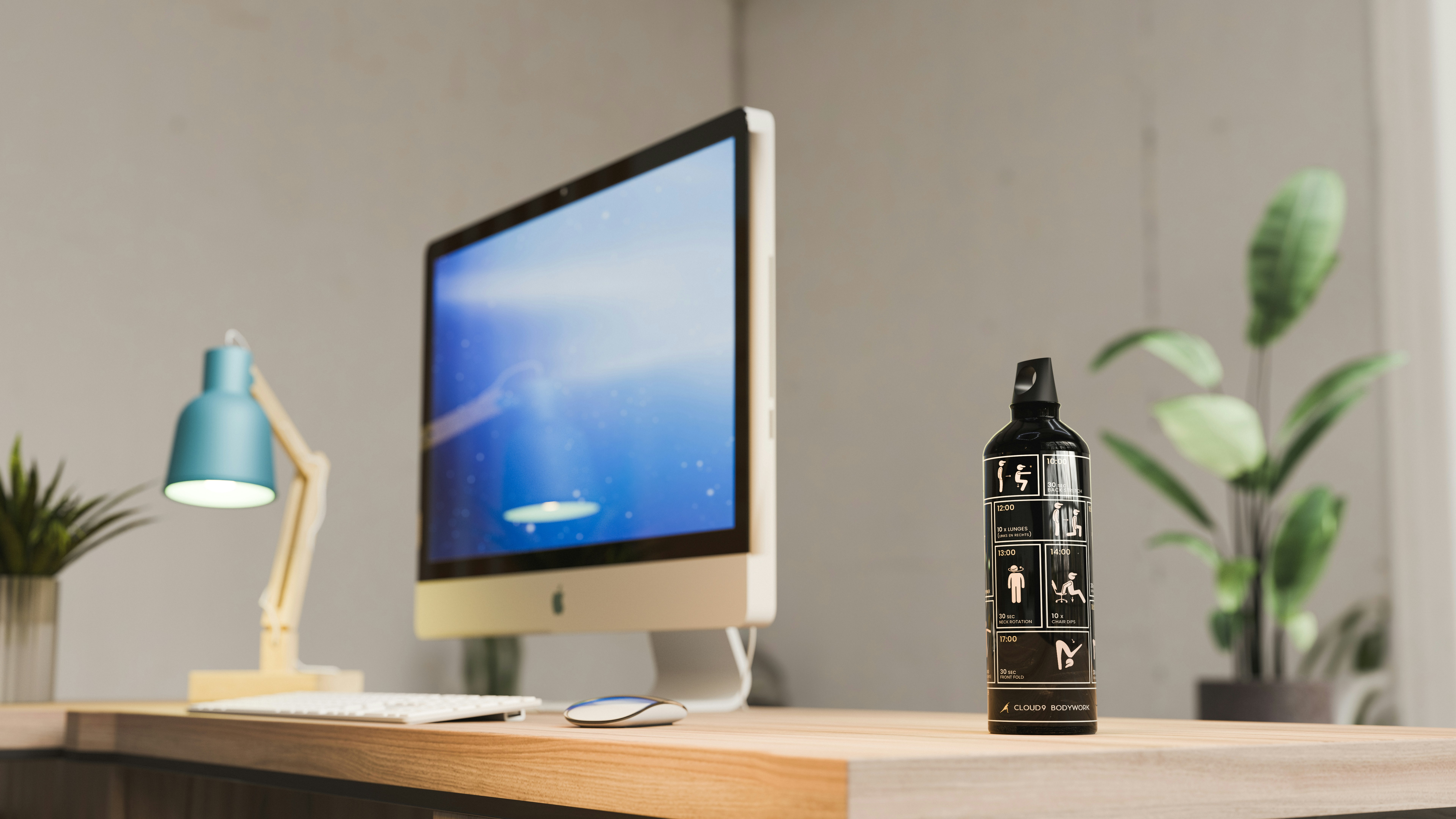 A bottle of e - liquid sitting on a desk next to a computer photo ...