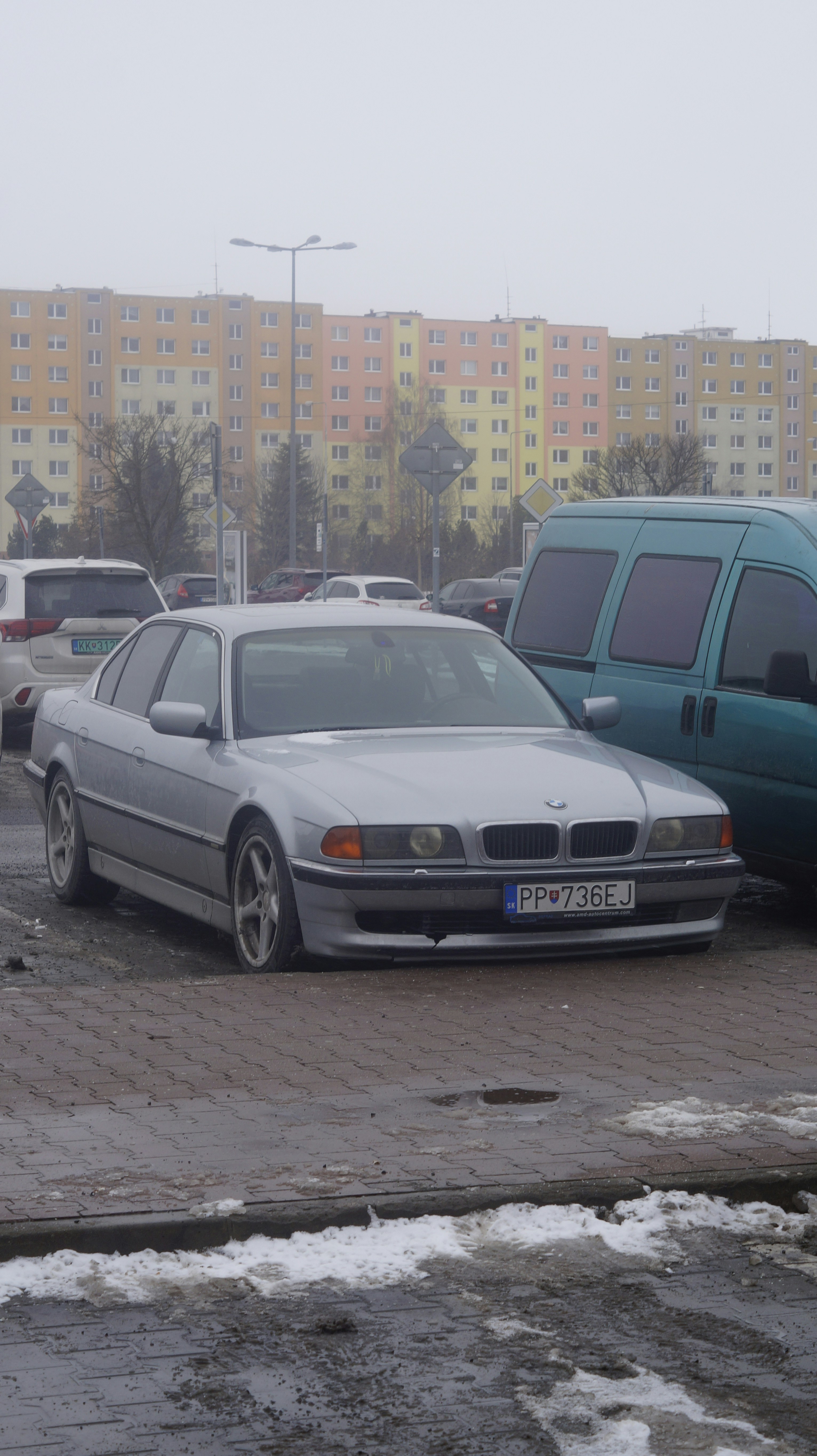 A silver car parked in a parking lot next to other cars photo – Free ...