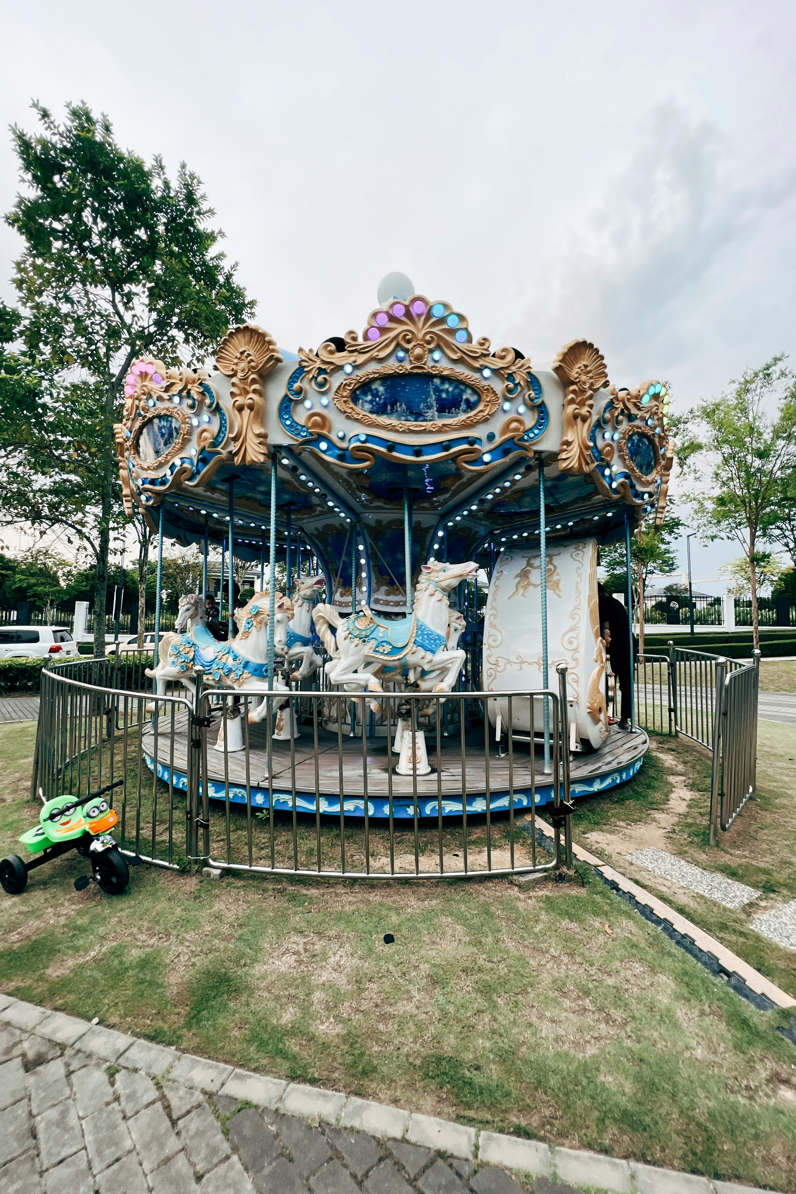 Ornate Carousel Amid a Quiet Park Under Overcast Sky