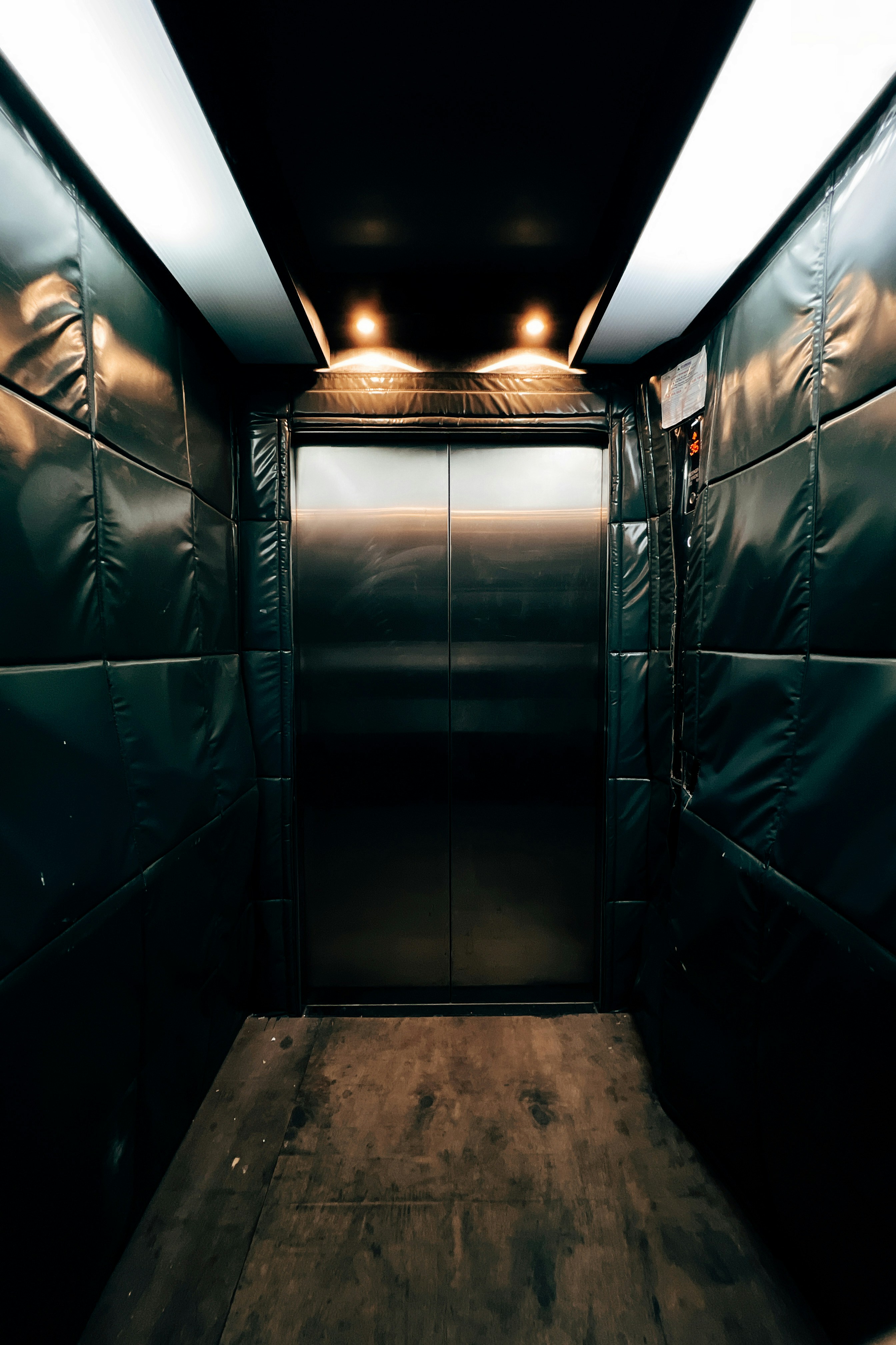 End of the Hall: Stainless Silence in a Narrow Elevator Shaft