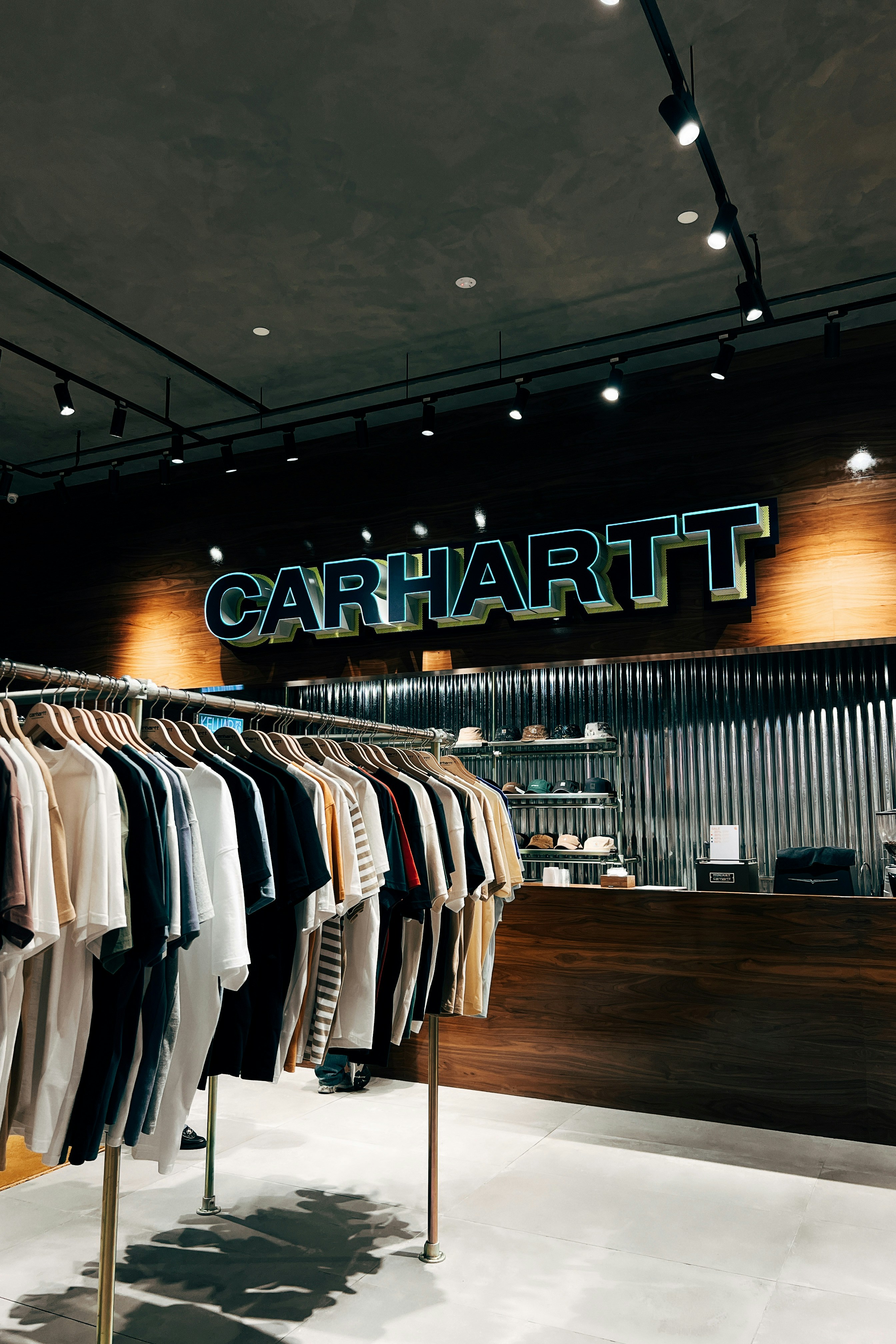 A clothing store with a rack of shirts photo – Free Furniture Image on ...