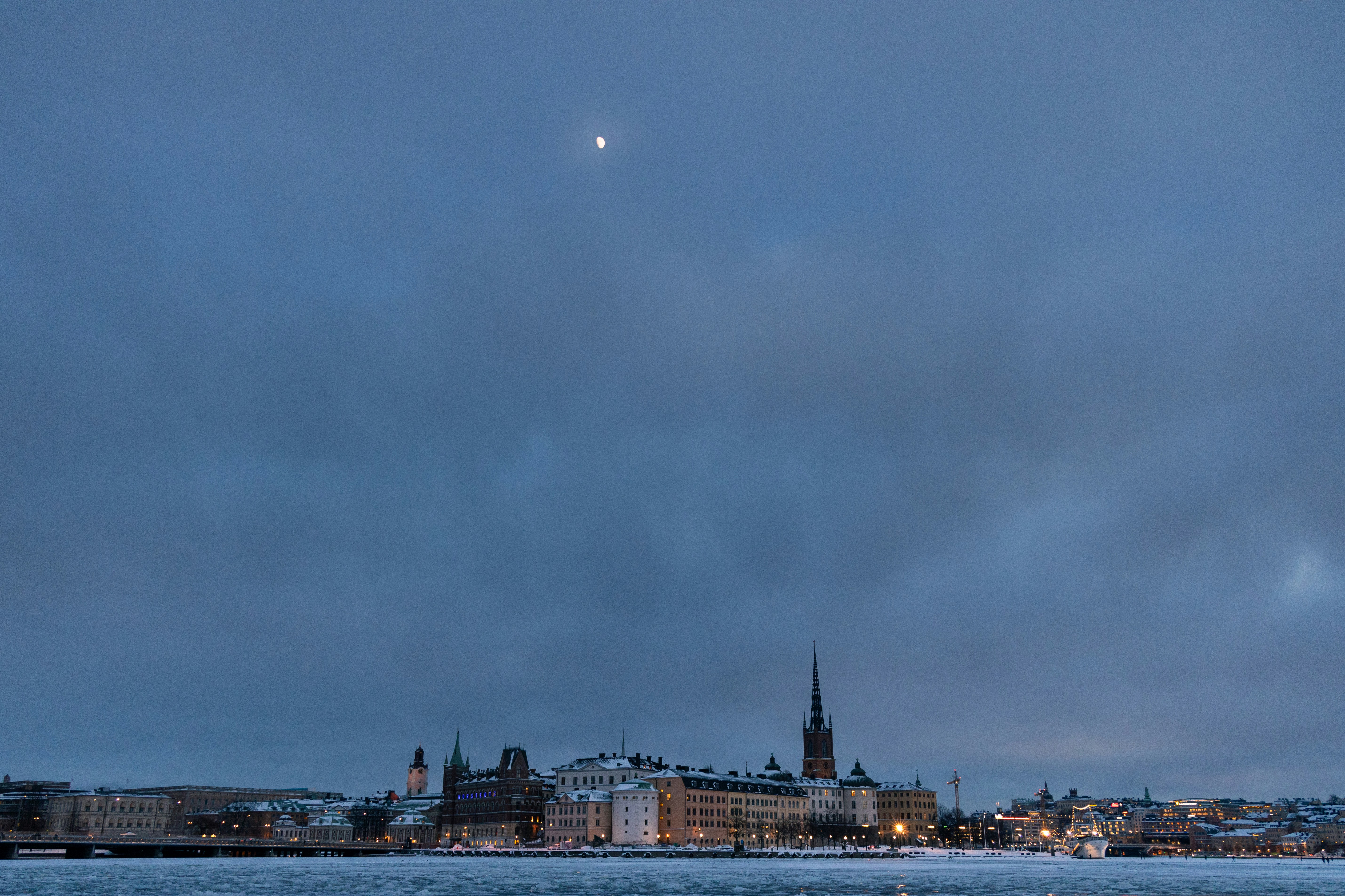 Moonlit Spire Against a Velvet Skyline over a Calm Nordic Harbor