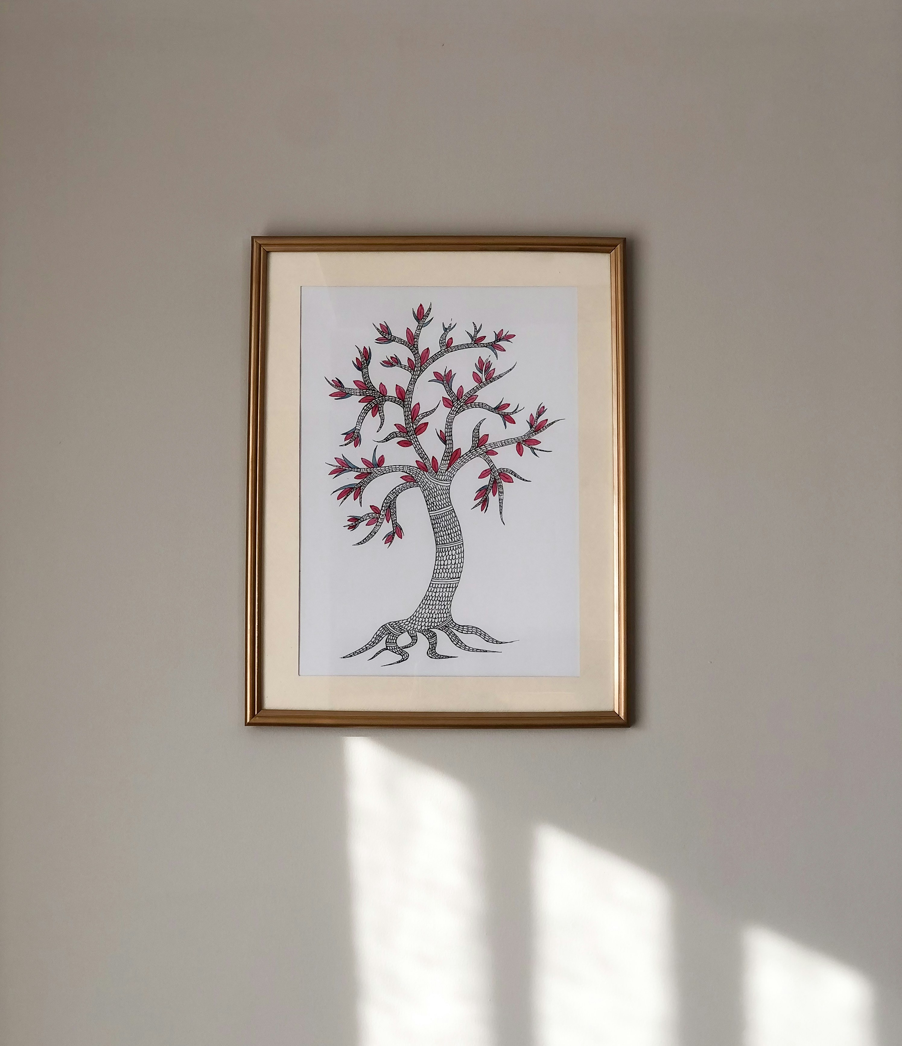 Crimson Leaves in a Gilded Frame: A Quiet Tree on a Neutral Wall