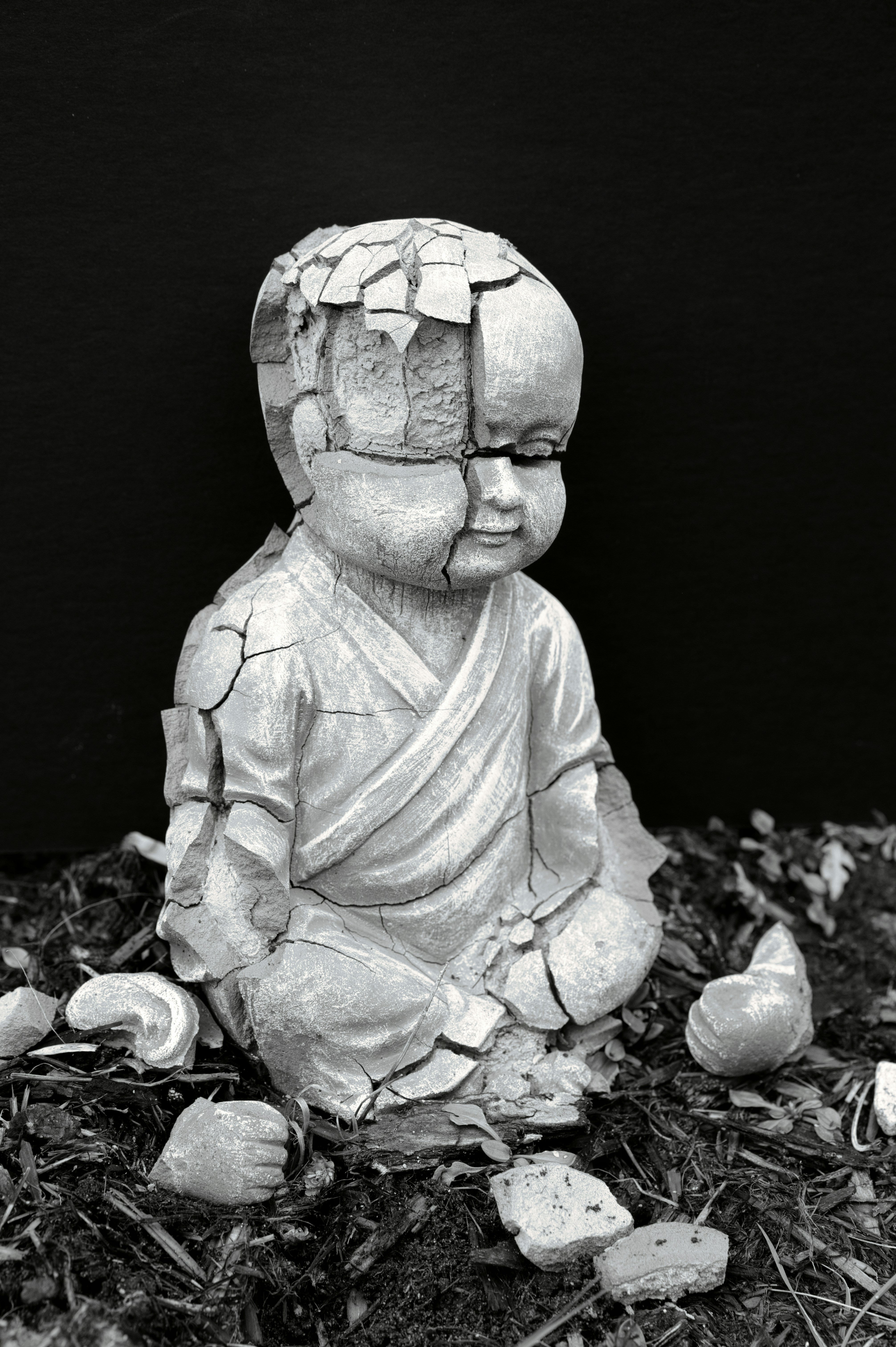 The ravages of time | a statue of a buddha sitting on the ground