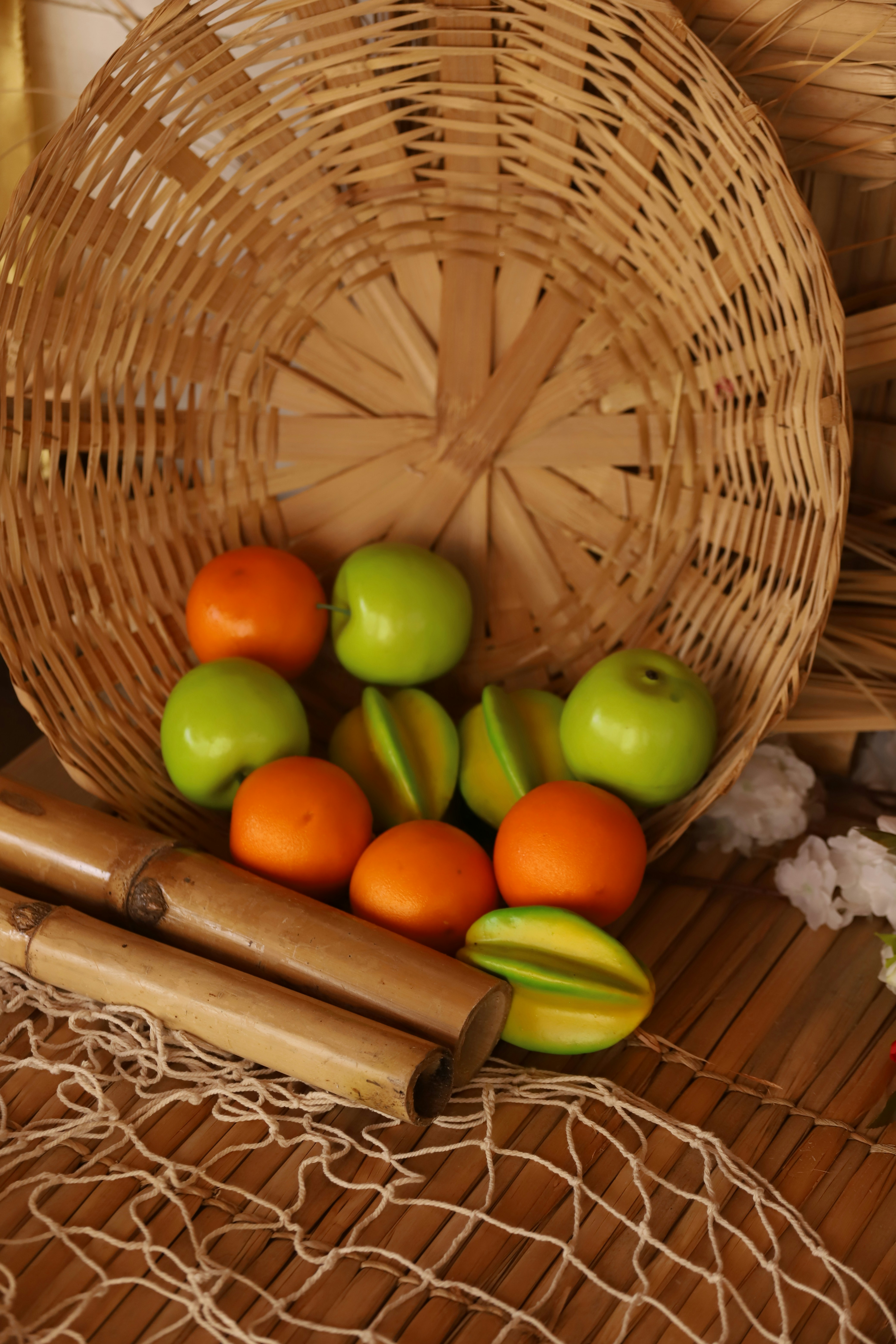a wicker basket filled with apples and oranges