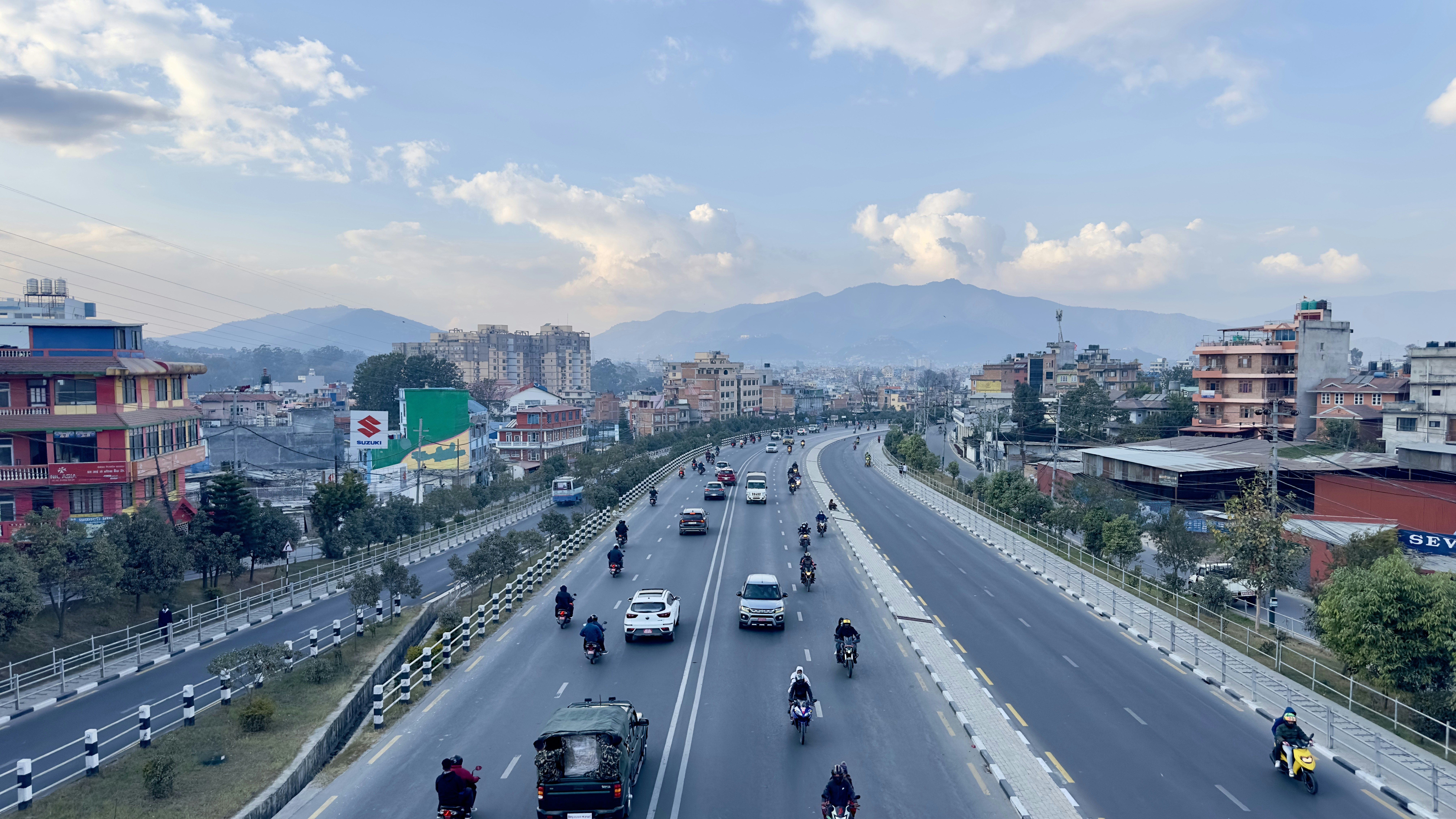 a group of people riding bikes down a street