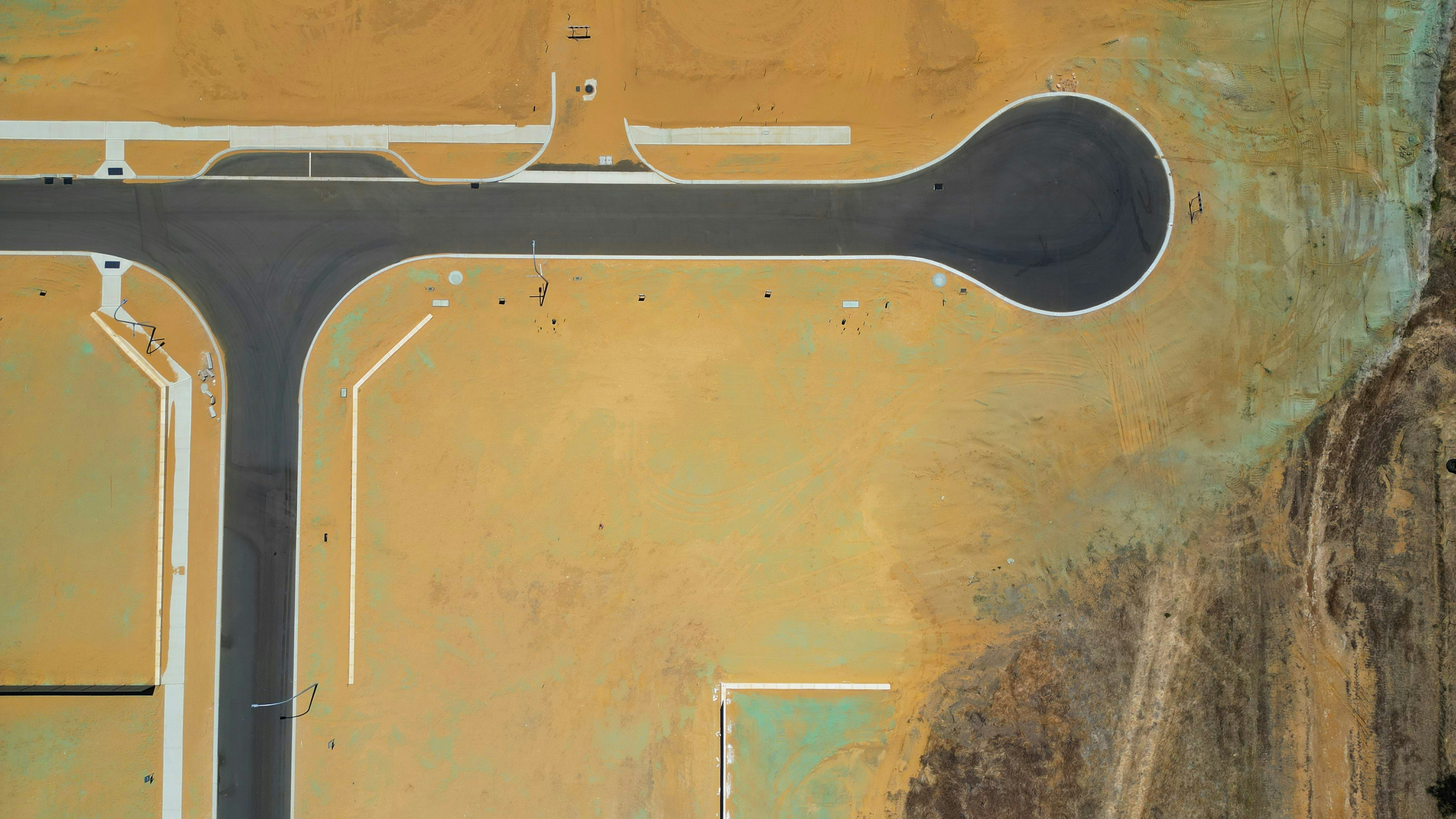 an aerial view of a road in the desert
