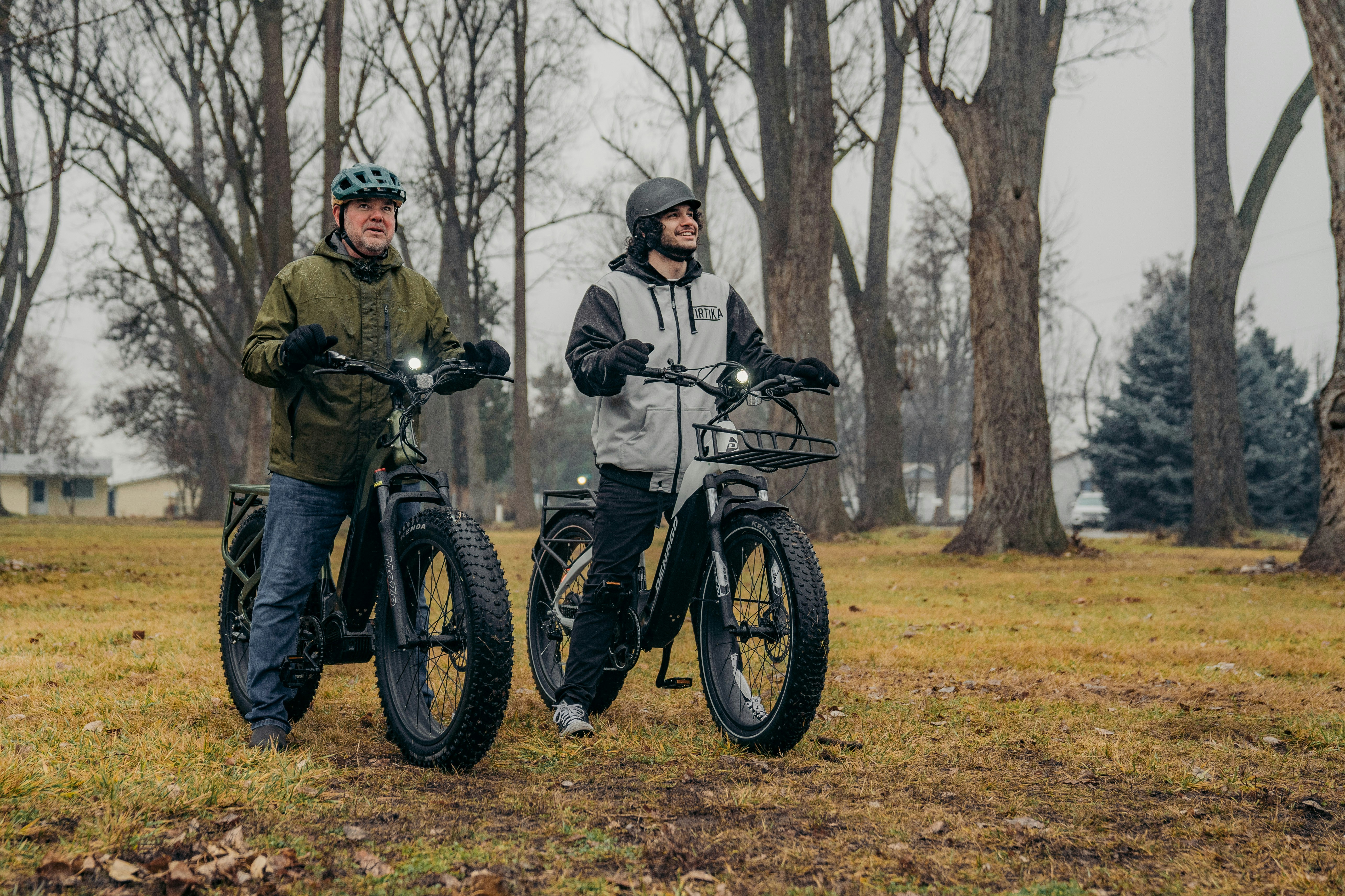 Muted Light, Shared Paths: Electric Bikers Pause in a Leaf-Littered Park