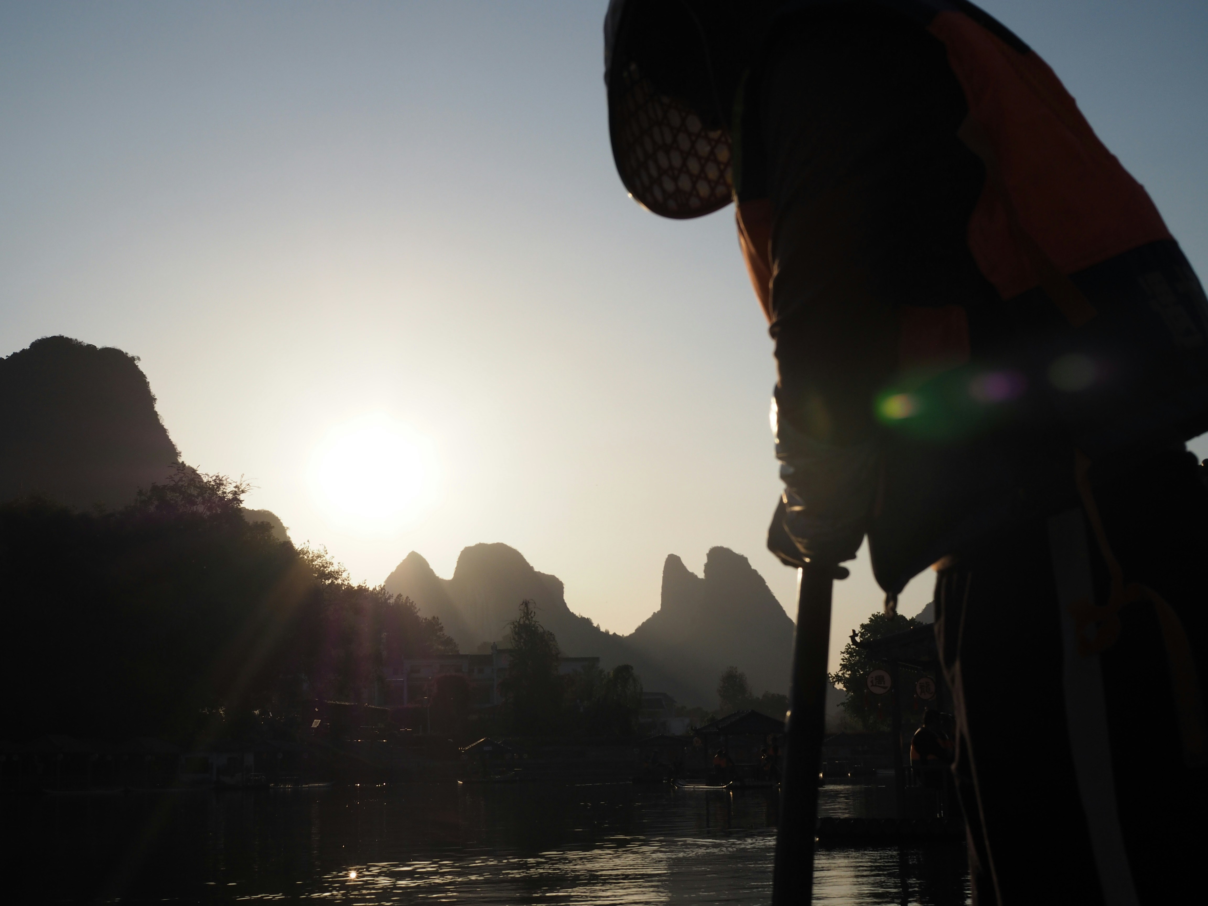Sunlit Silhouette Over Karst Peaks at Dusk