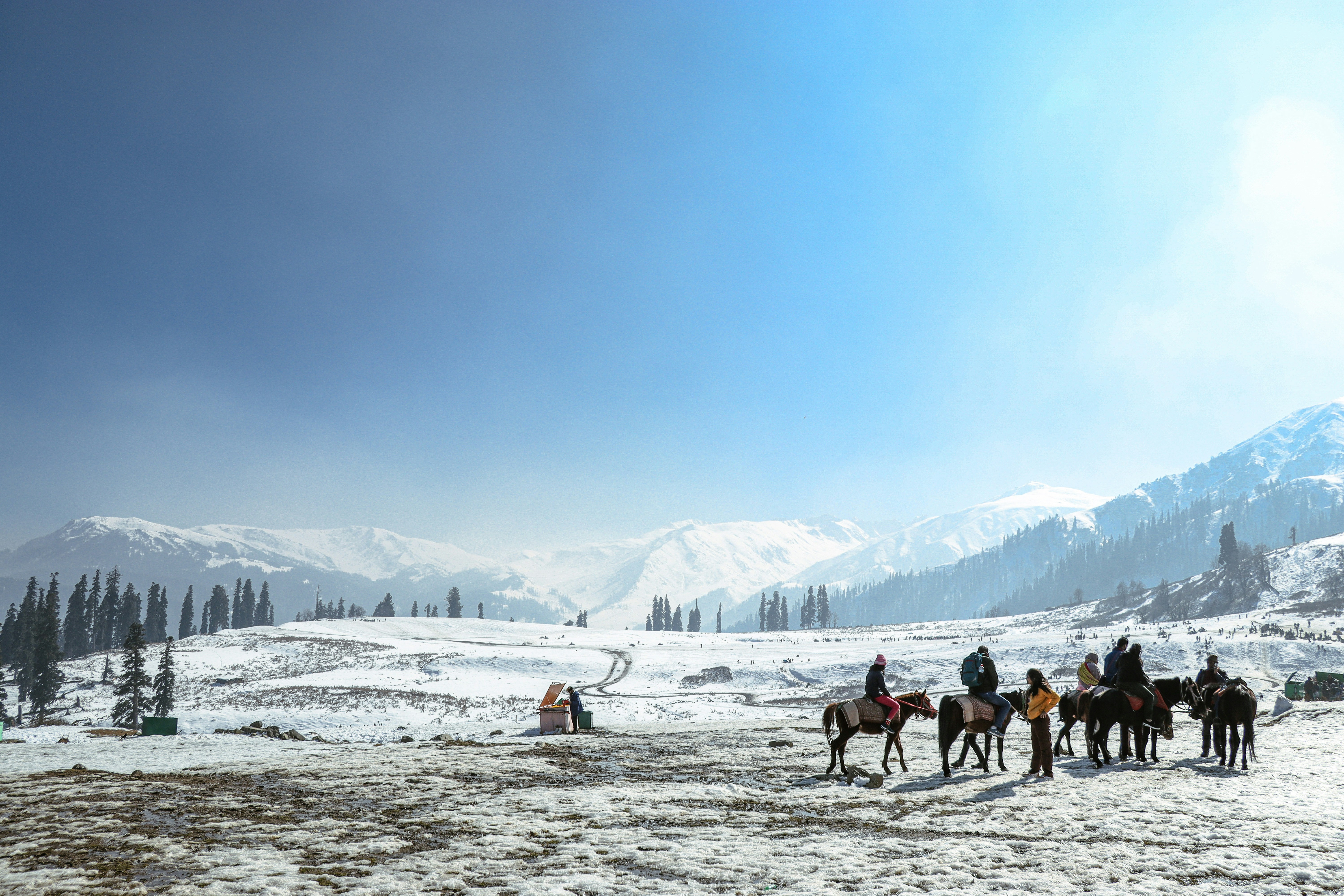 A group of people riding horses in the snow photo – Free Kashmir Image ...