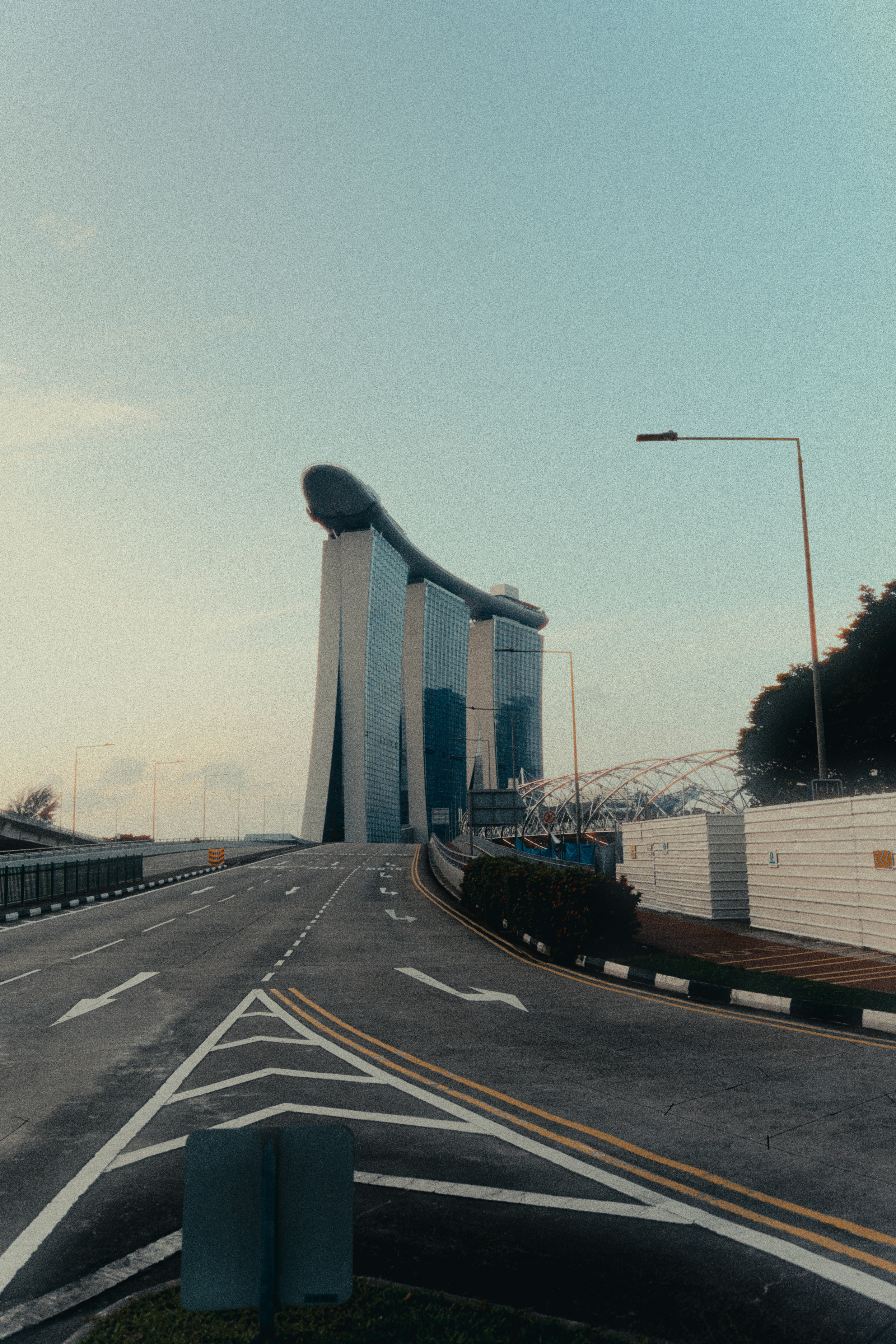 Road to the Curved Tower: An Empty Highway toward a Futuristic Skyline