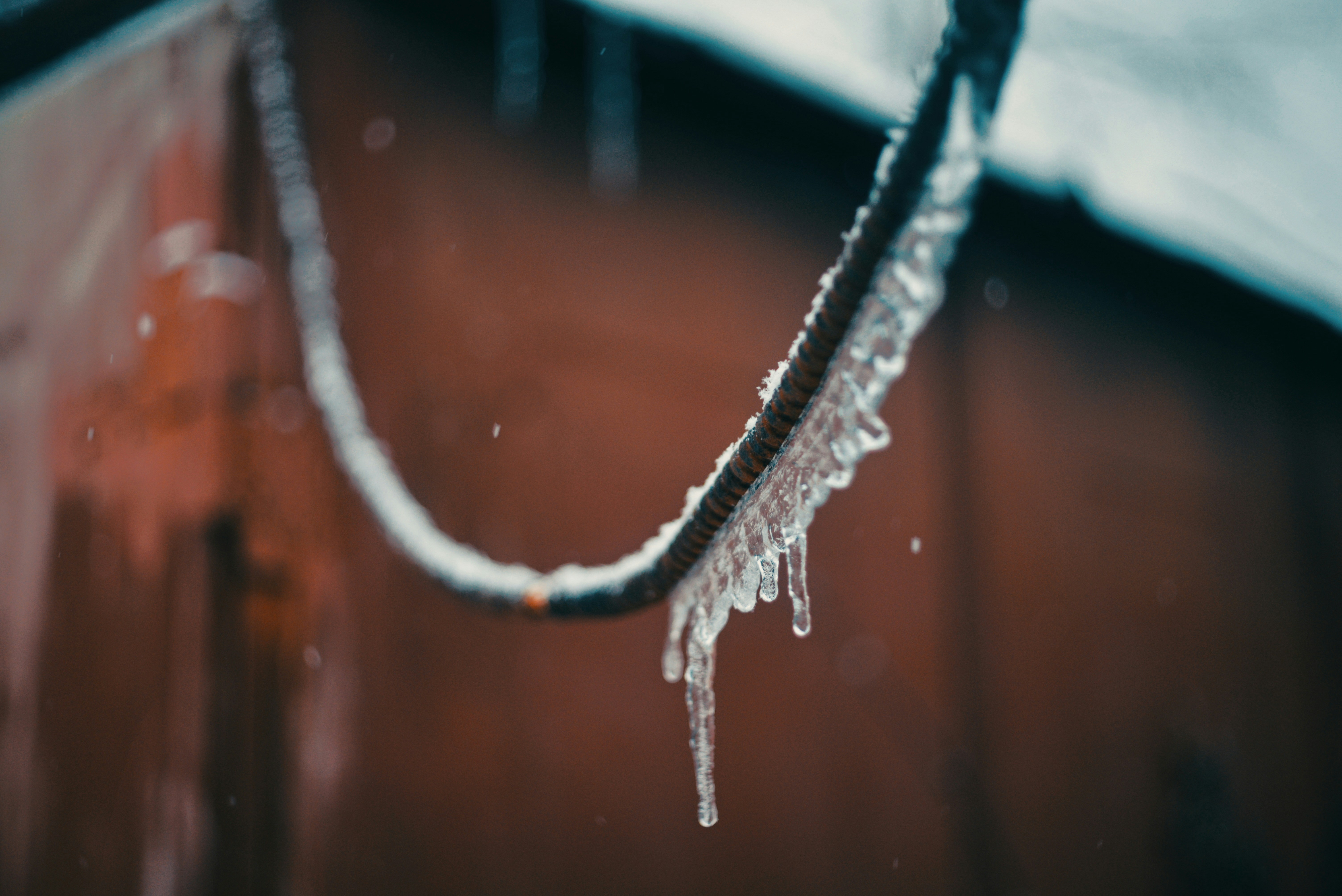 Frosted Curve: Icicles Draped on a Weathered Rope