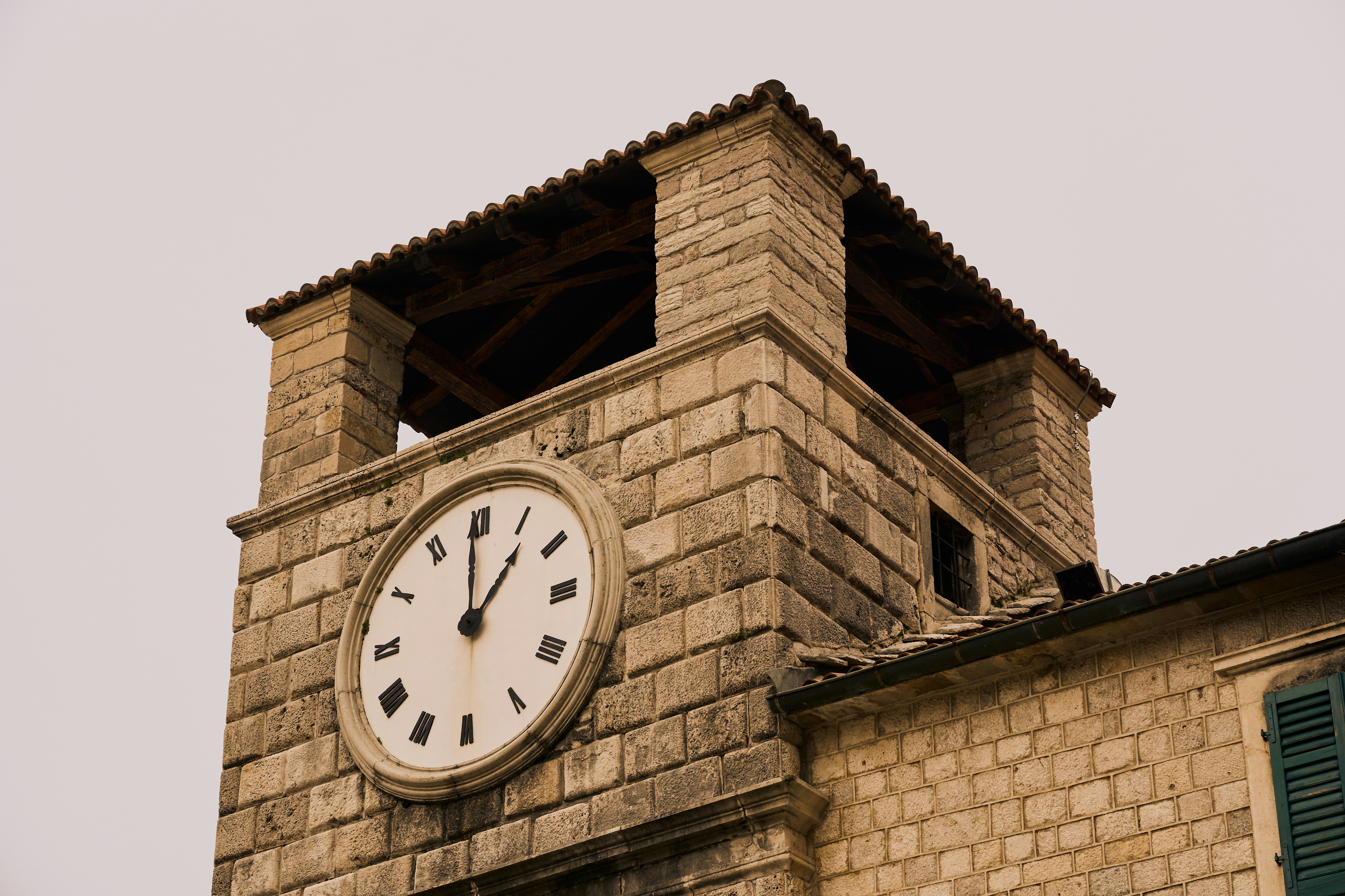 Timekeeper Against a Blush Sky: The Stone Clock Tower