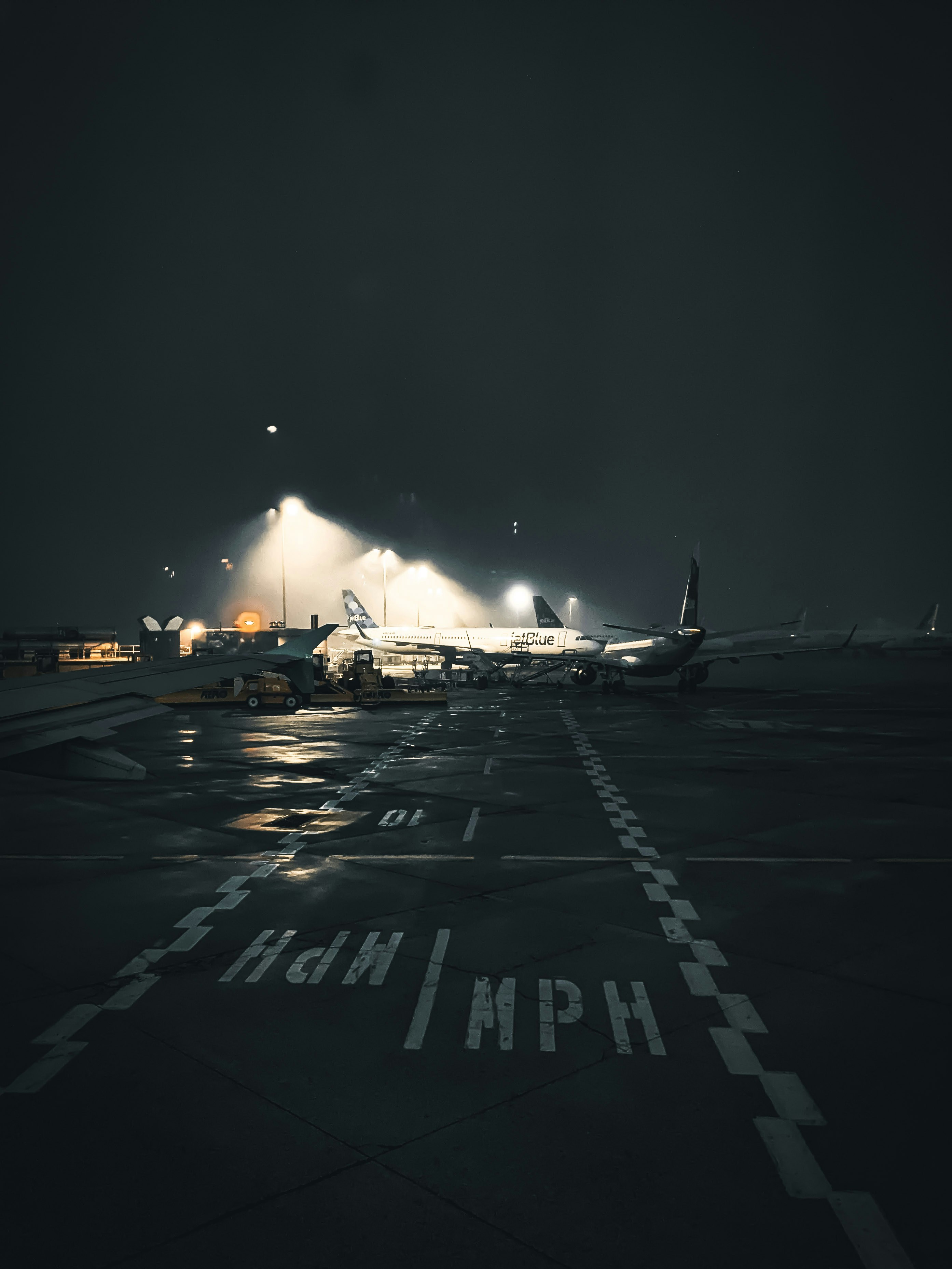 An airport runway at night with a plane on the runway photo – Free ...