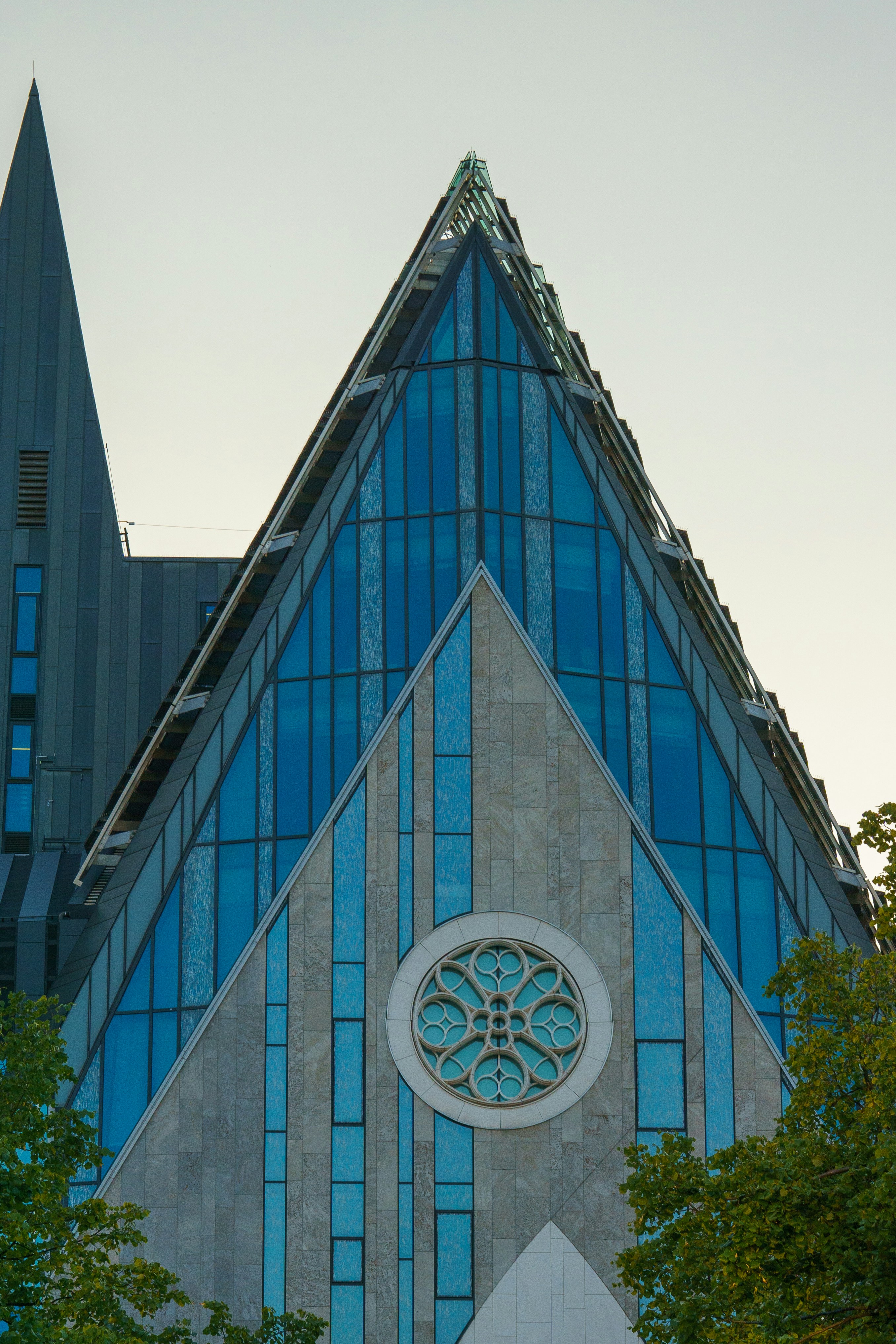 Blue Glass Pyramid: Rose Window at the Heart of a Modern Cathedral Facade