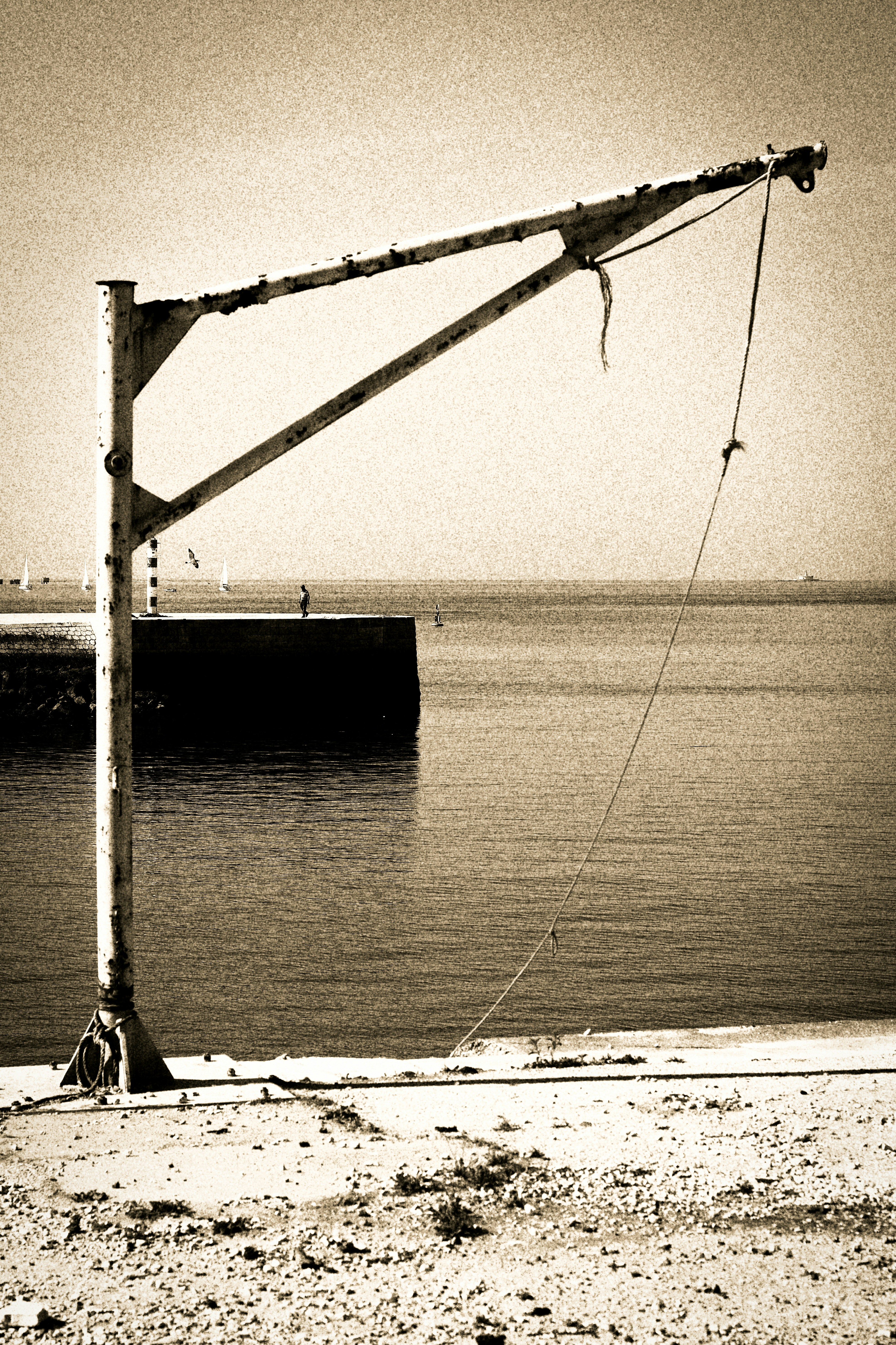 Weathered Harbormast Reaching Over a Quiet Sea