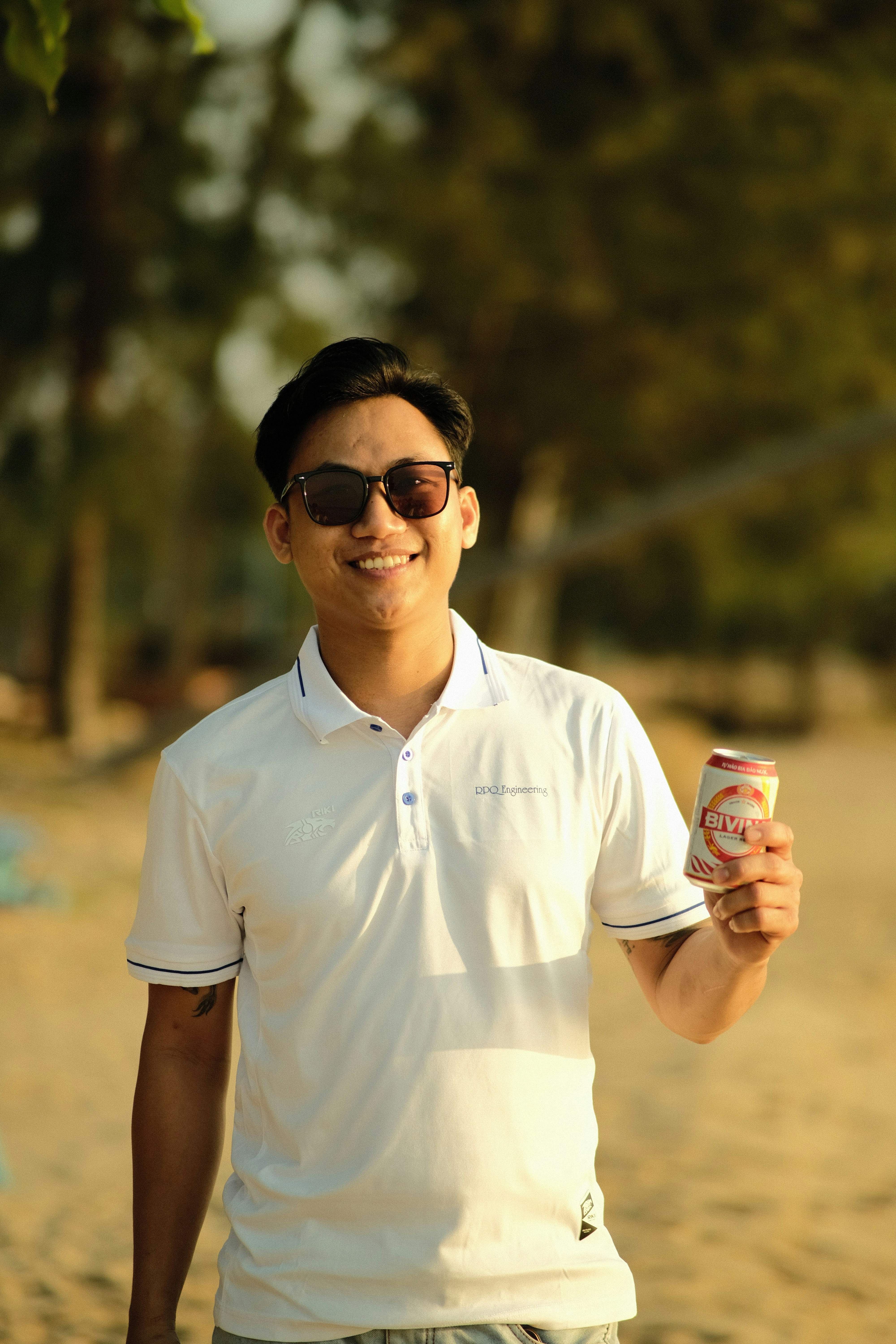 Sunlit Smile at the Shore: A Beachside Toast with a Can