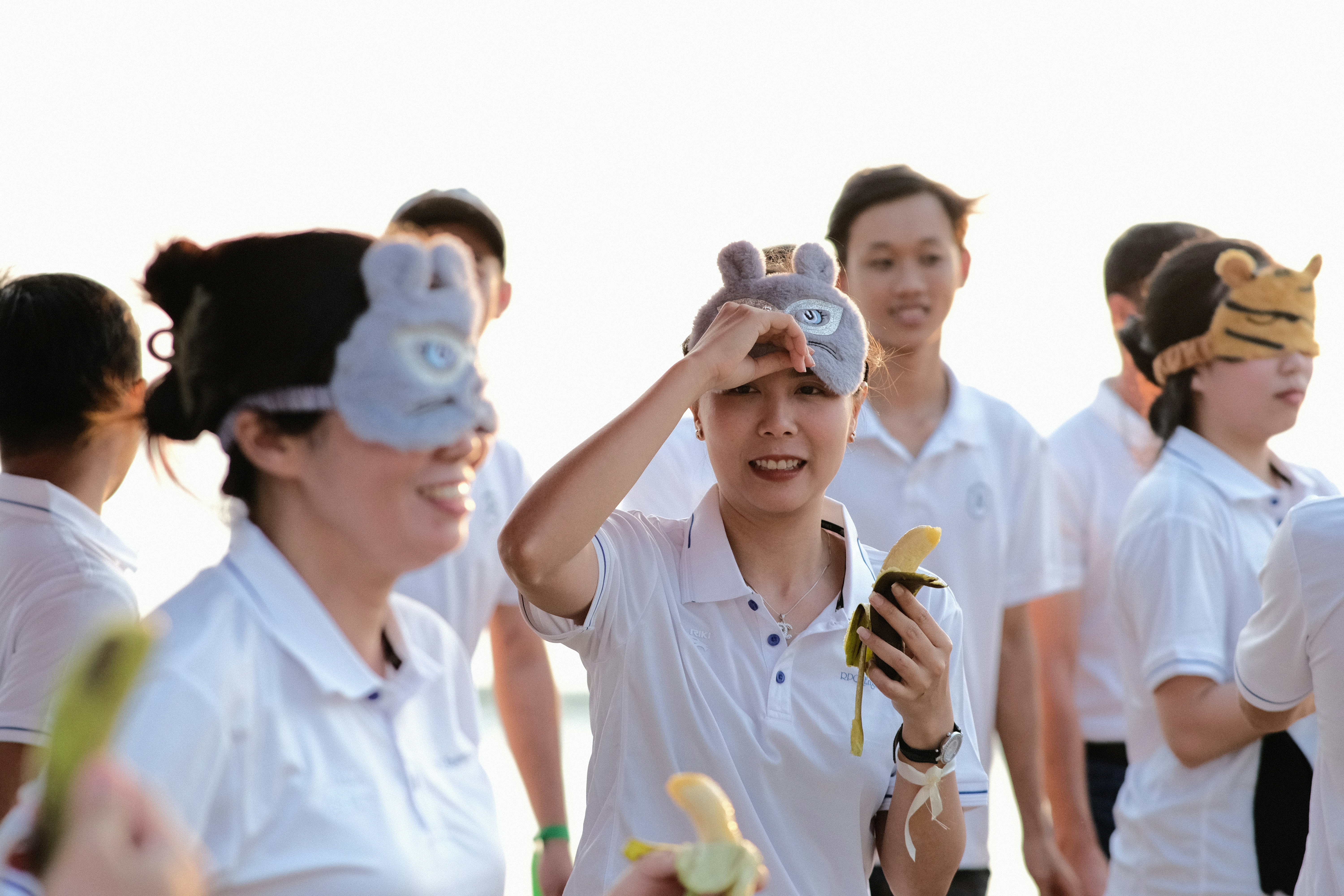 Sunlit Group in White Polo Masks: A Playful Moment Amid Masked Camaraderie