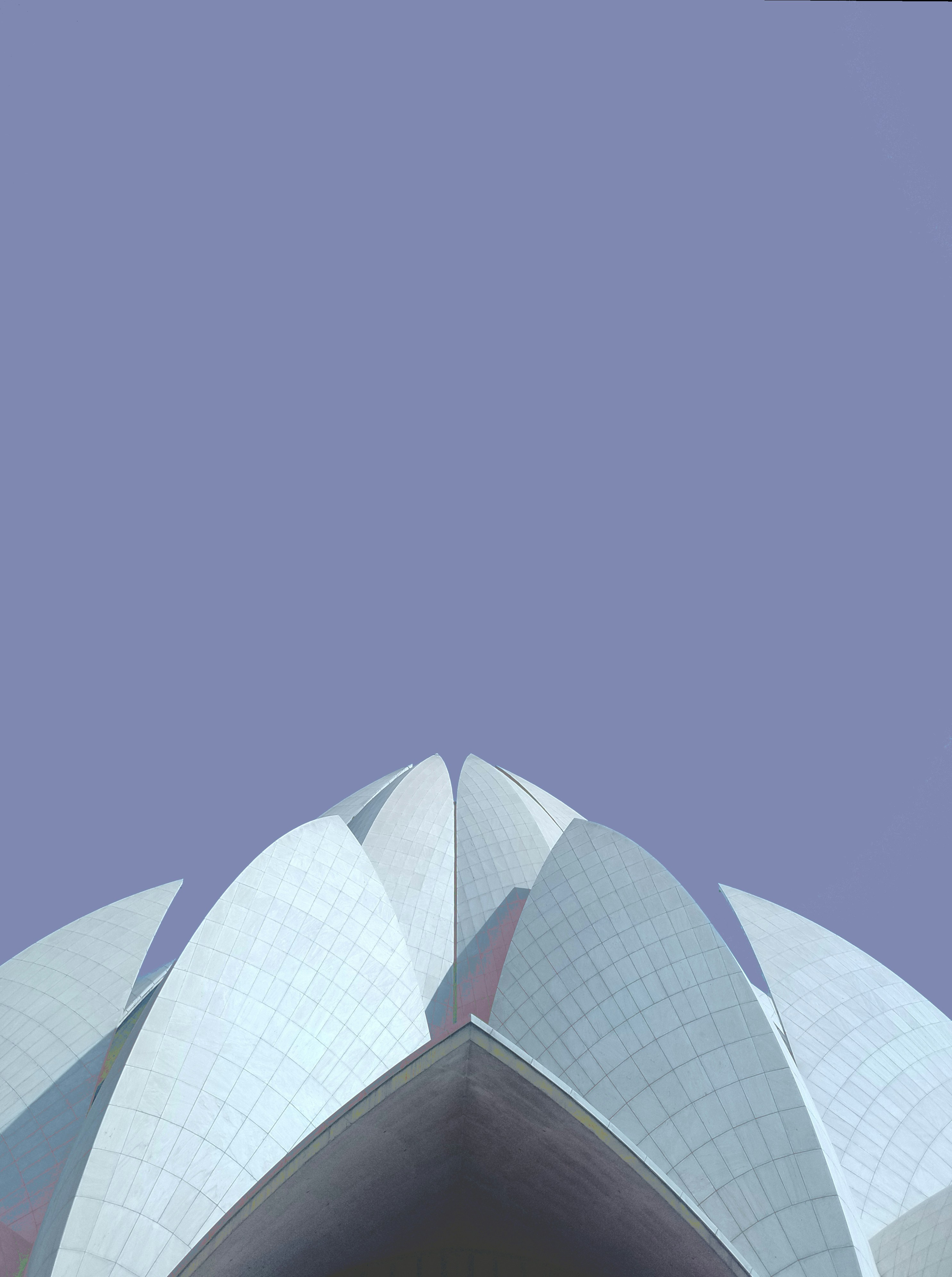 An airplane flying over a building with a clock on it's side photo ...