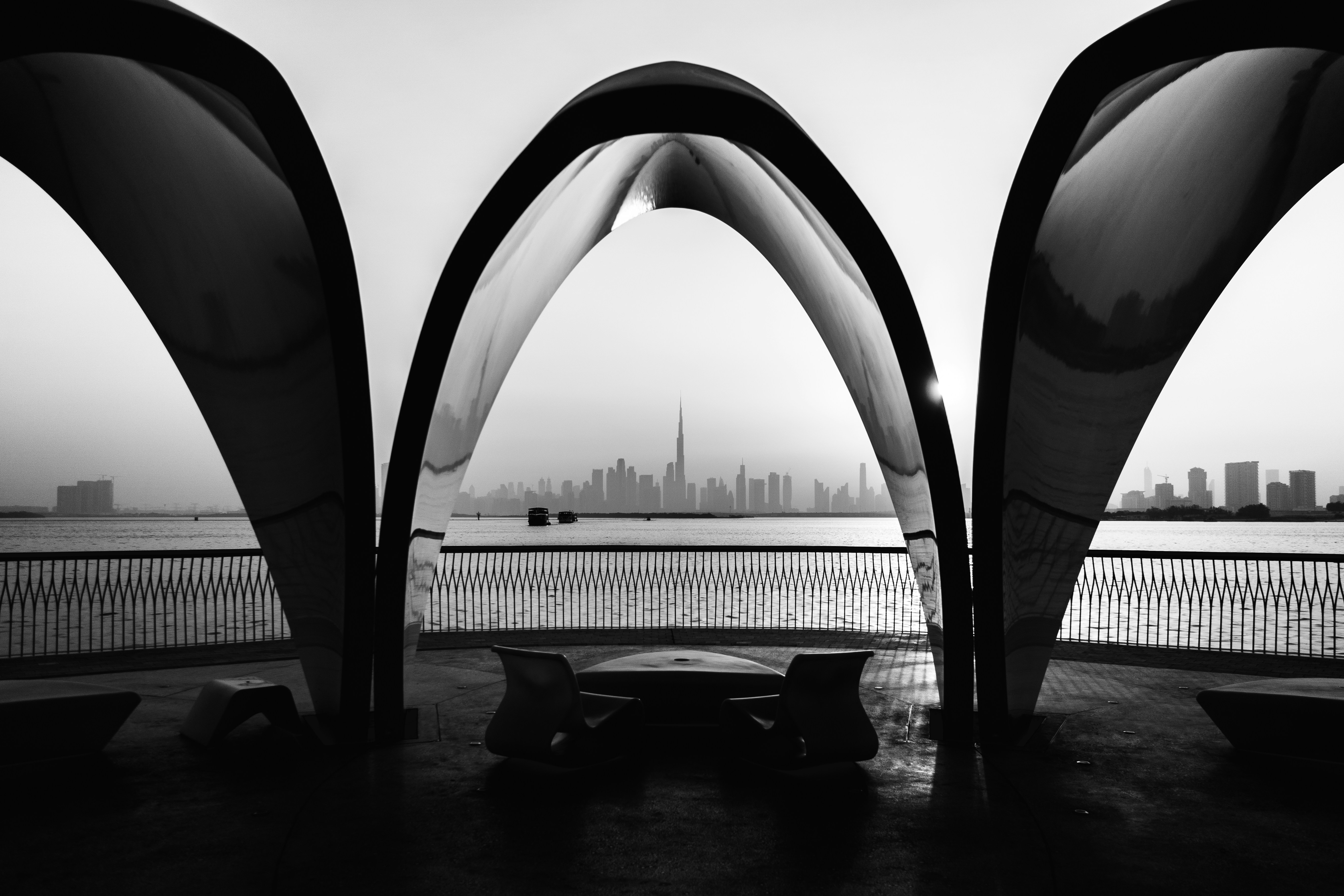 Symmetrical Arches Framing a Distant City Horizon