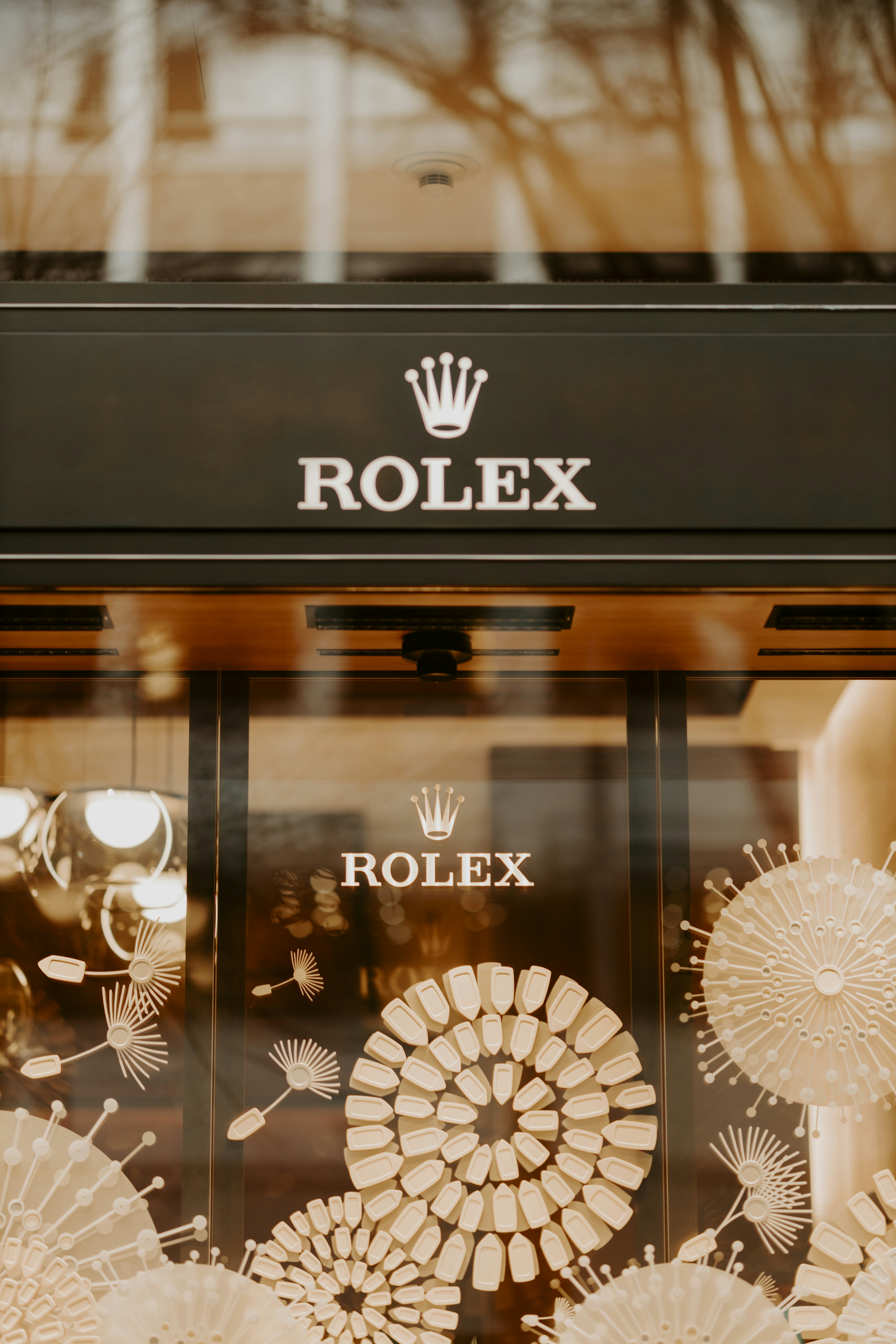 A rolex store front with paper fans in front of it photo – Free ...
