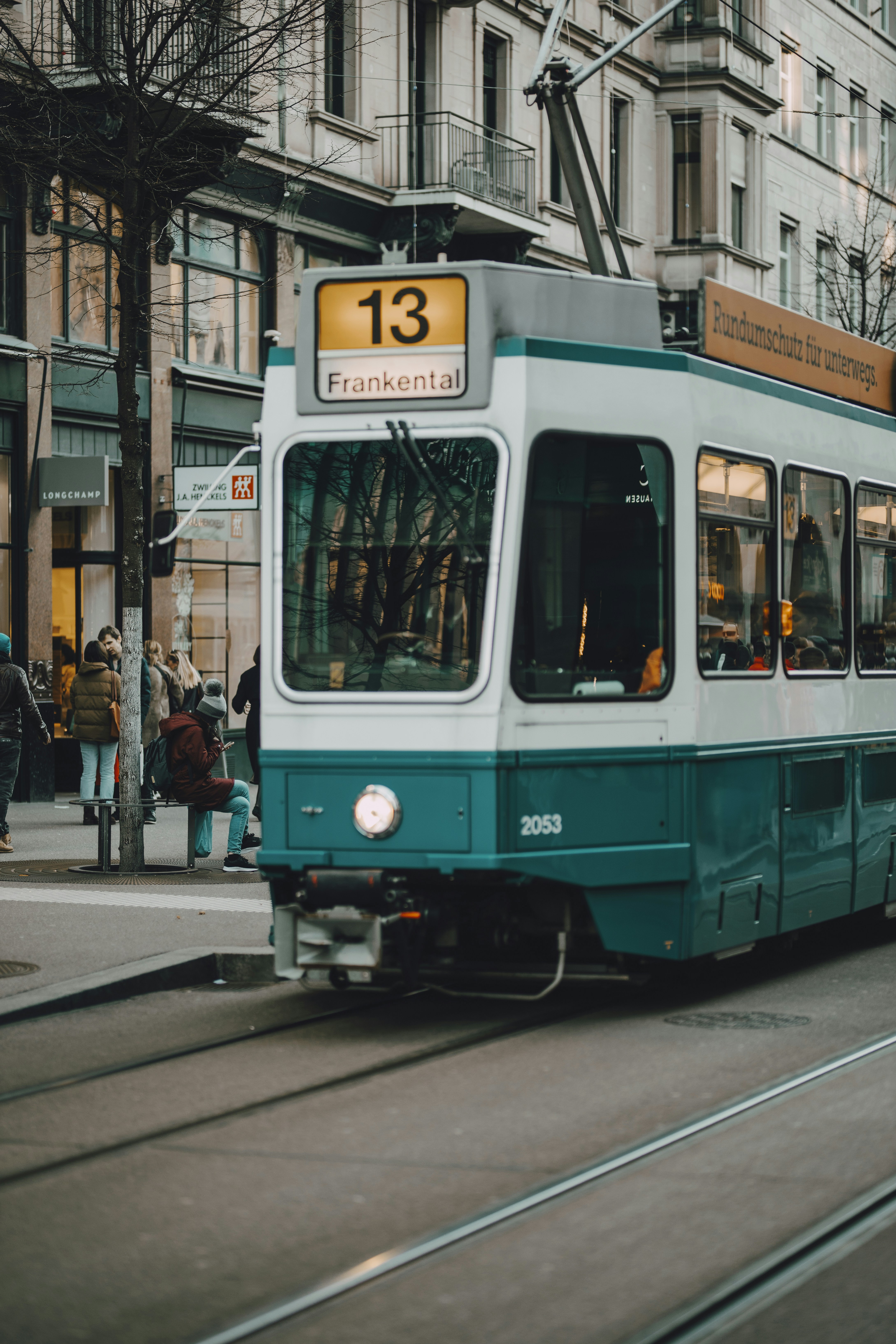 A blue and white trolley on a city street photo – Free Schweiz Image on ...