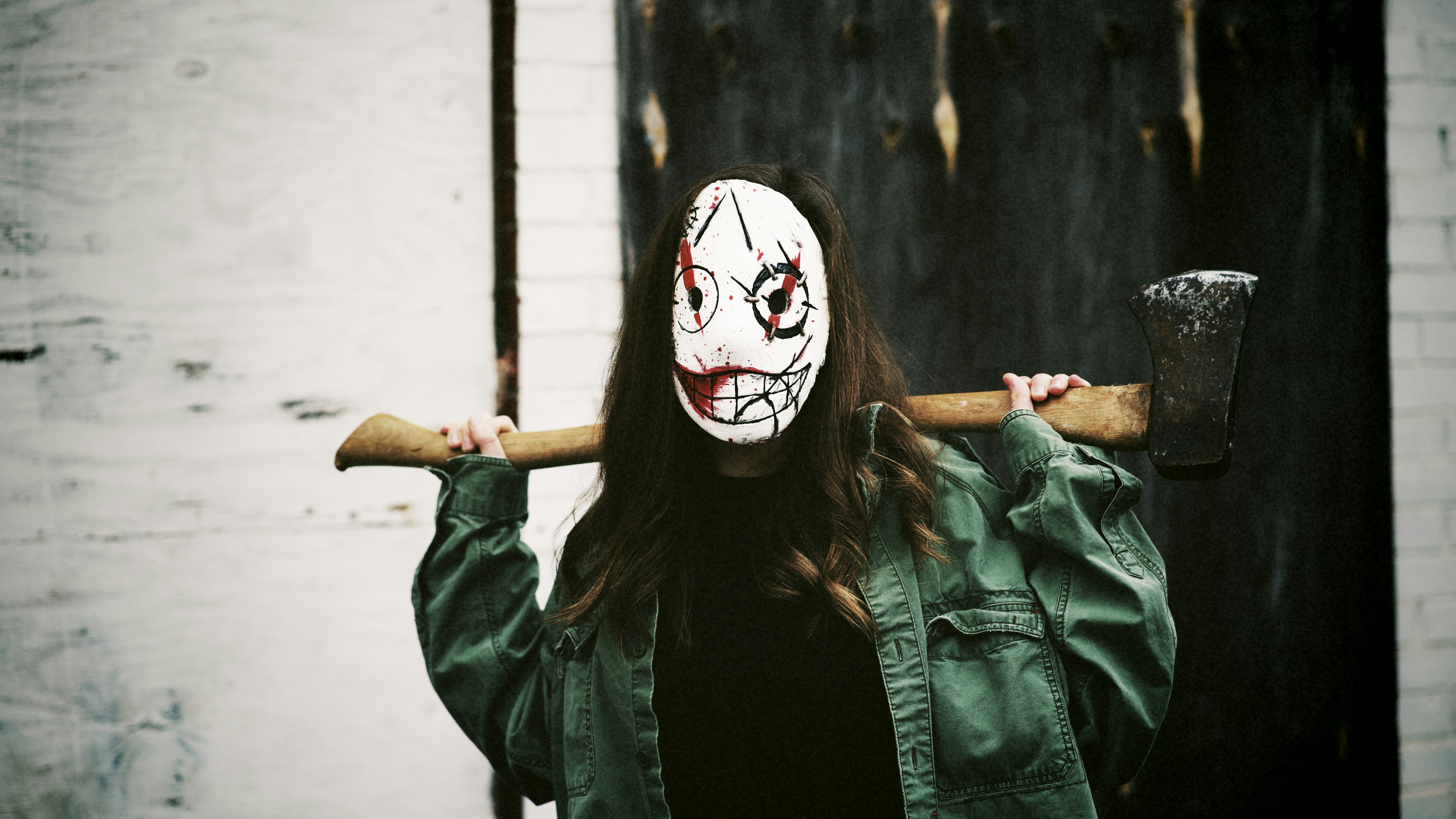 A woman wearing a creepy mask holding a hammer photo – Free Axe Image ...