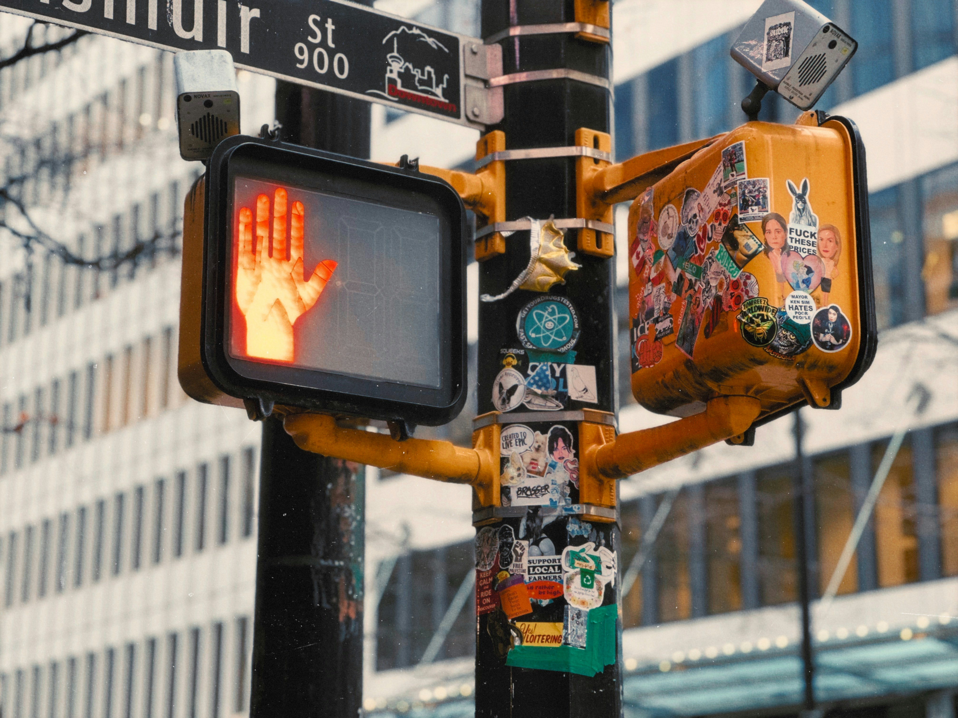 A traffic light with stickers all over it photo – Free Light Image on ...