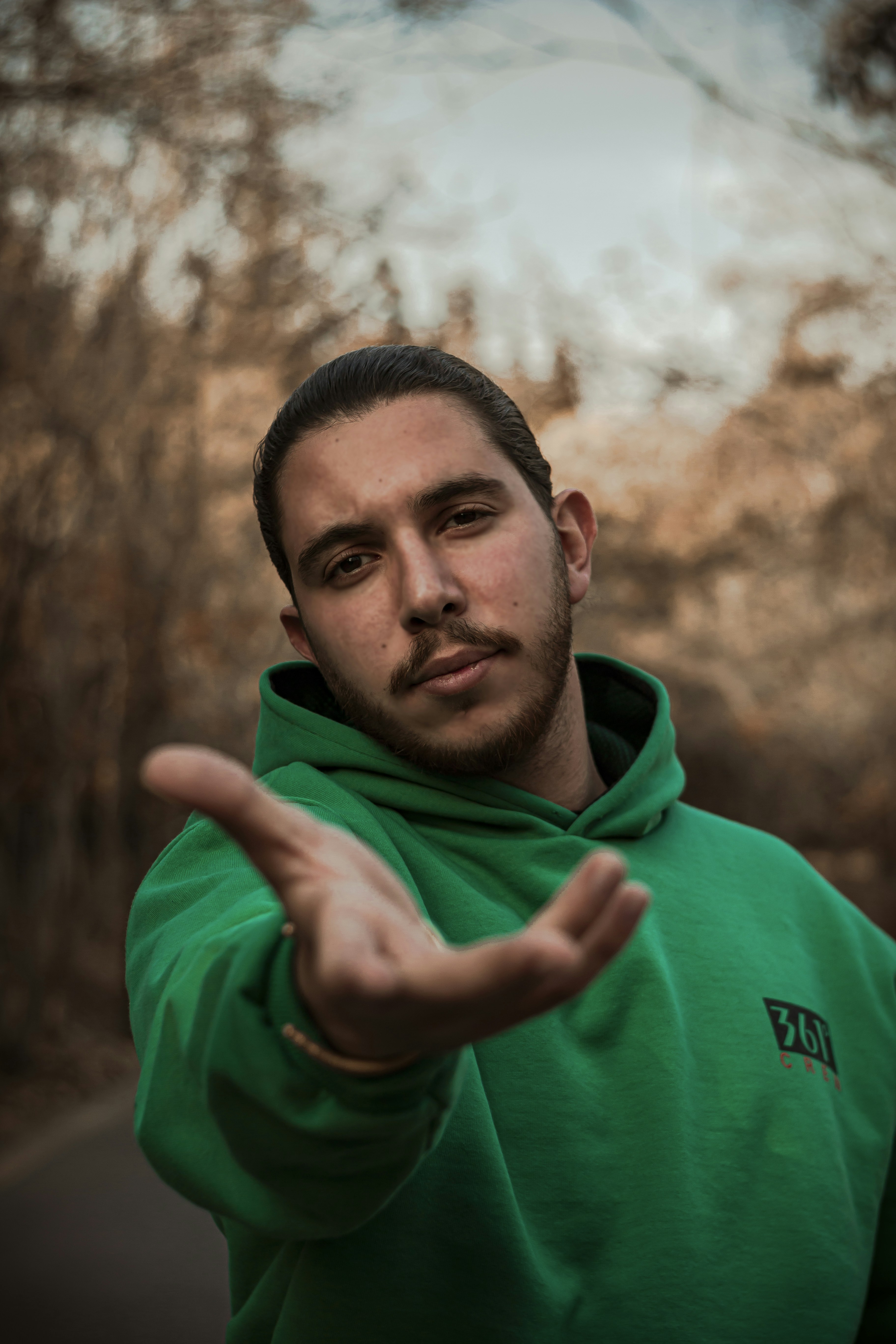 Green Hoodie Conduit: A Forest Portrait That Reaches for You