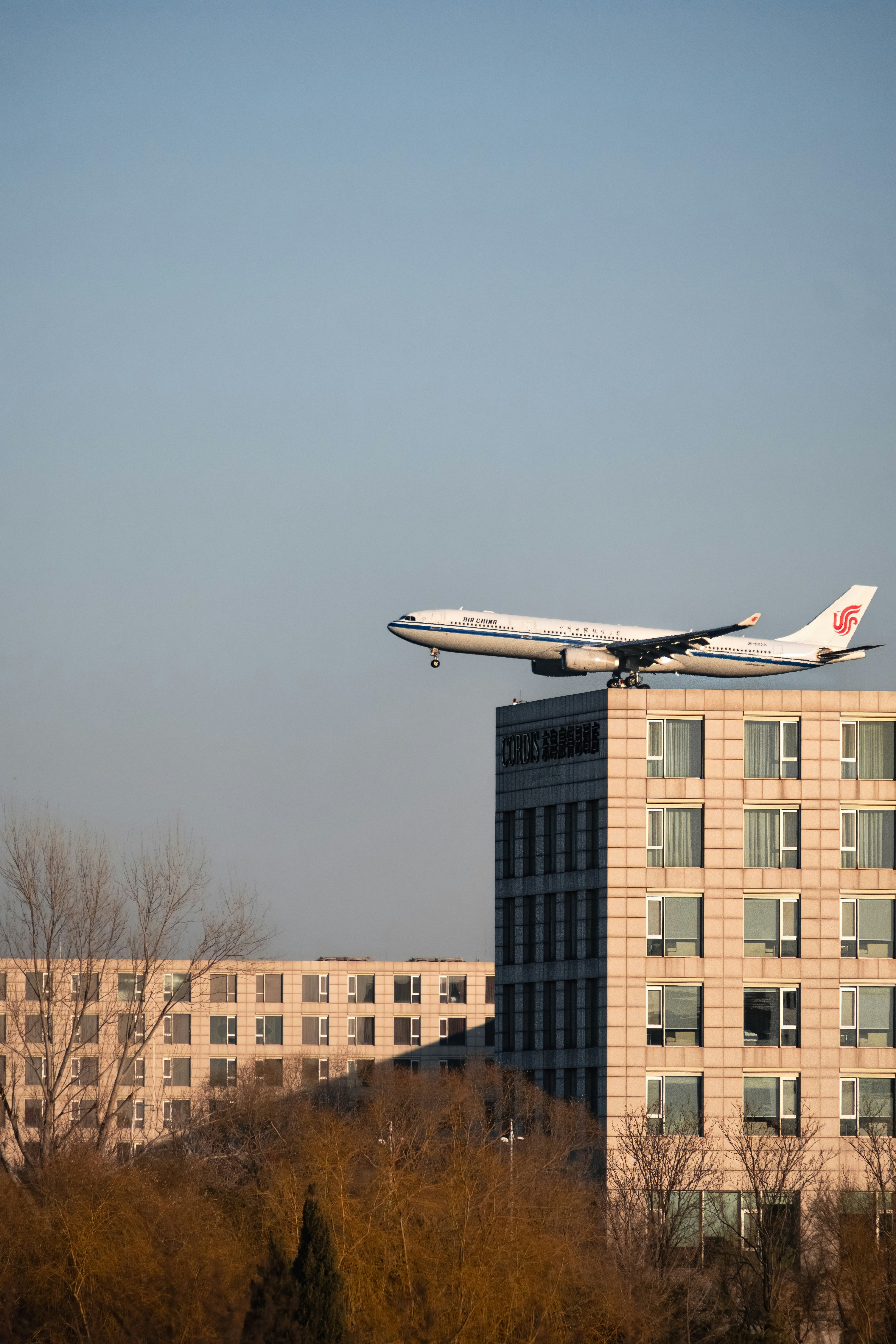 Runway Rendezvous: A Jet Touches Down Over a Corporate Skyline