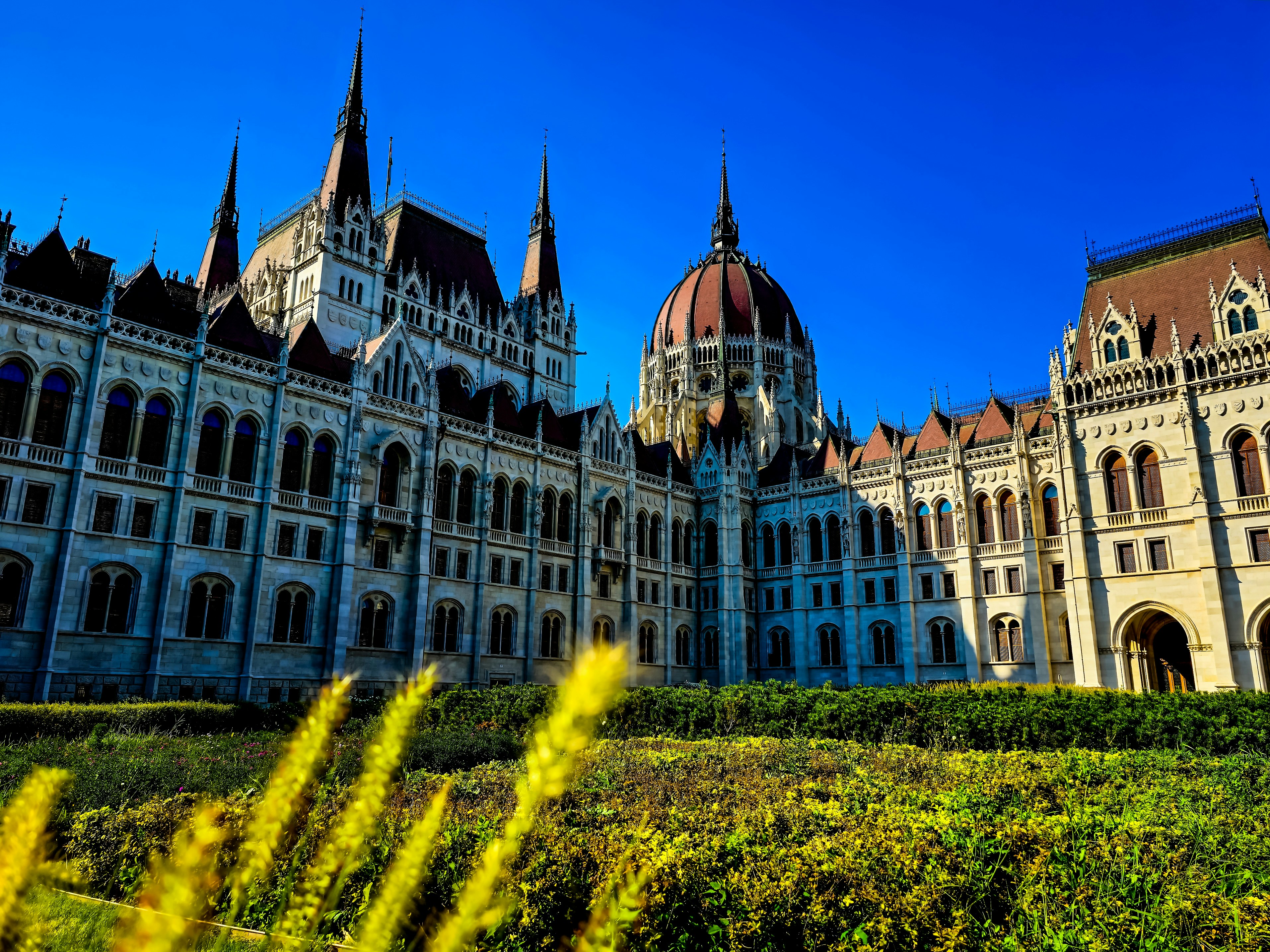 Cerulean Sky Over Budapest Parliament: A Gothic-Byzantine Facade in Sharp Focus