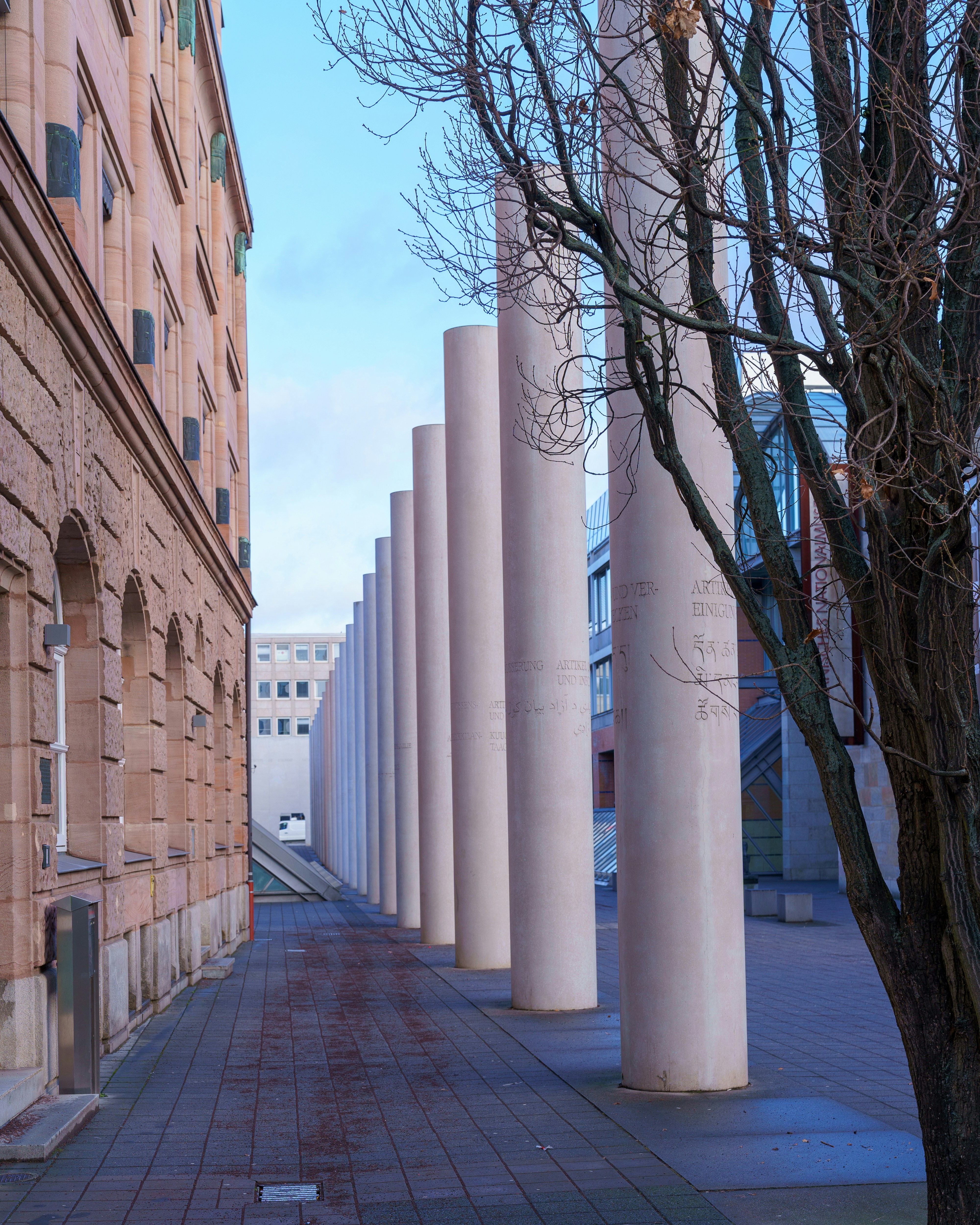 Pillars of the City: A Narrow Corridor Framed by Brick and Bare Trees