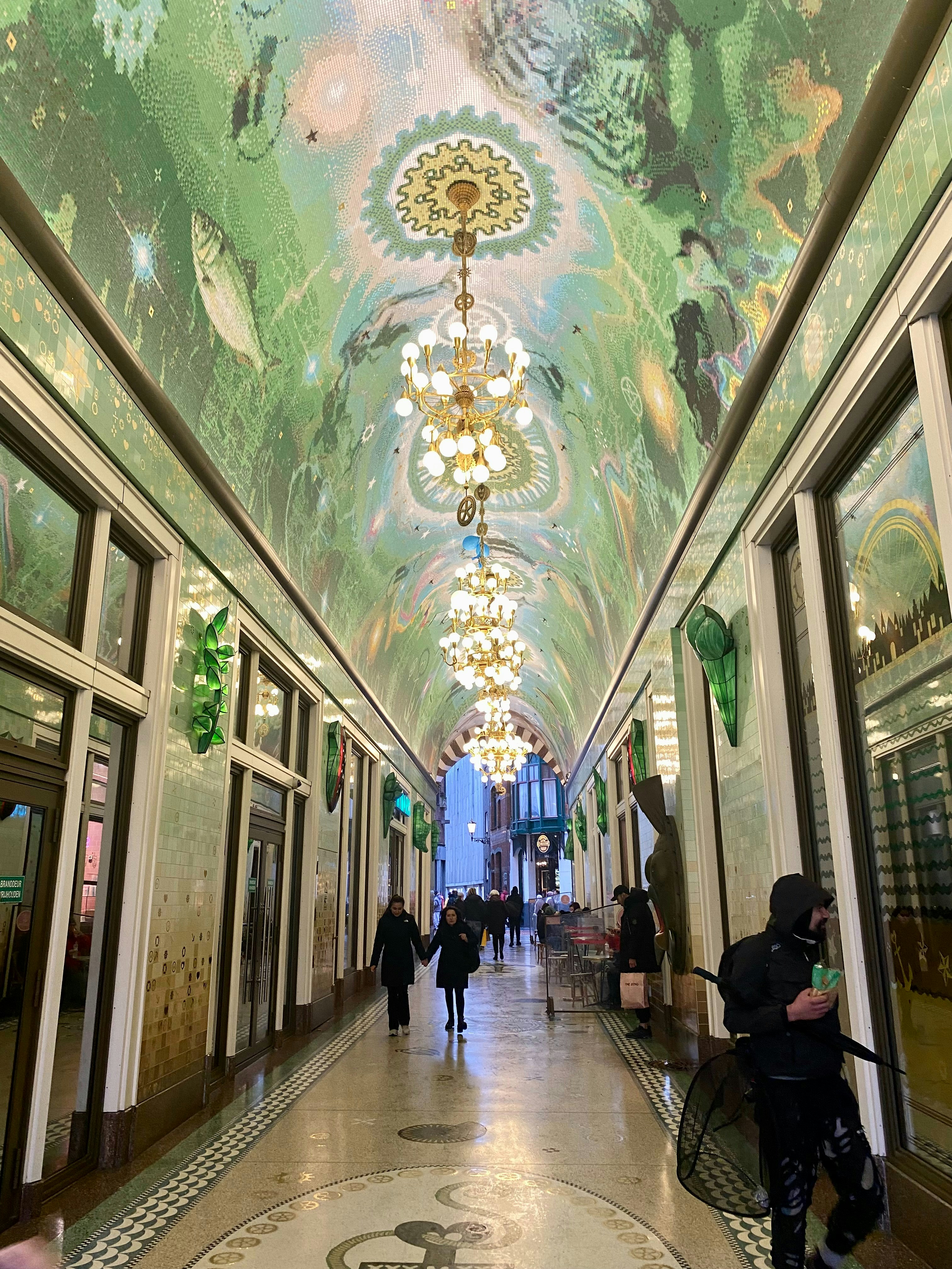 Chandeliers Over a Painted Arcade: A Quiet Walk Through Colorful Vaults