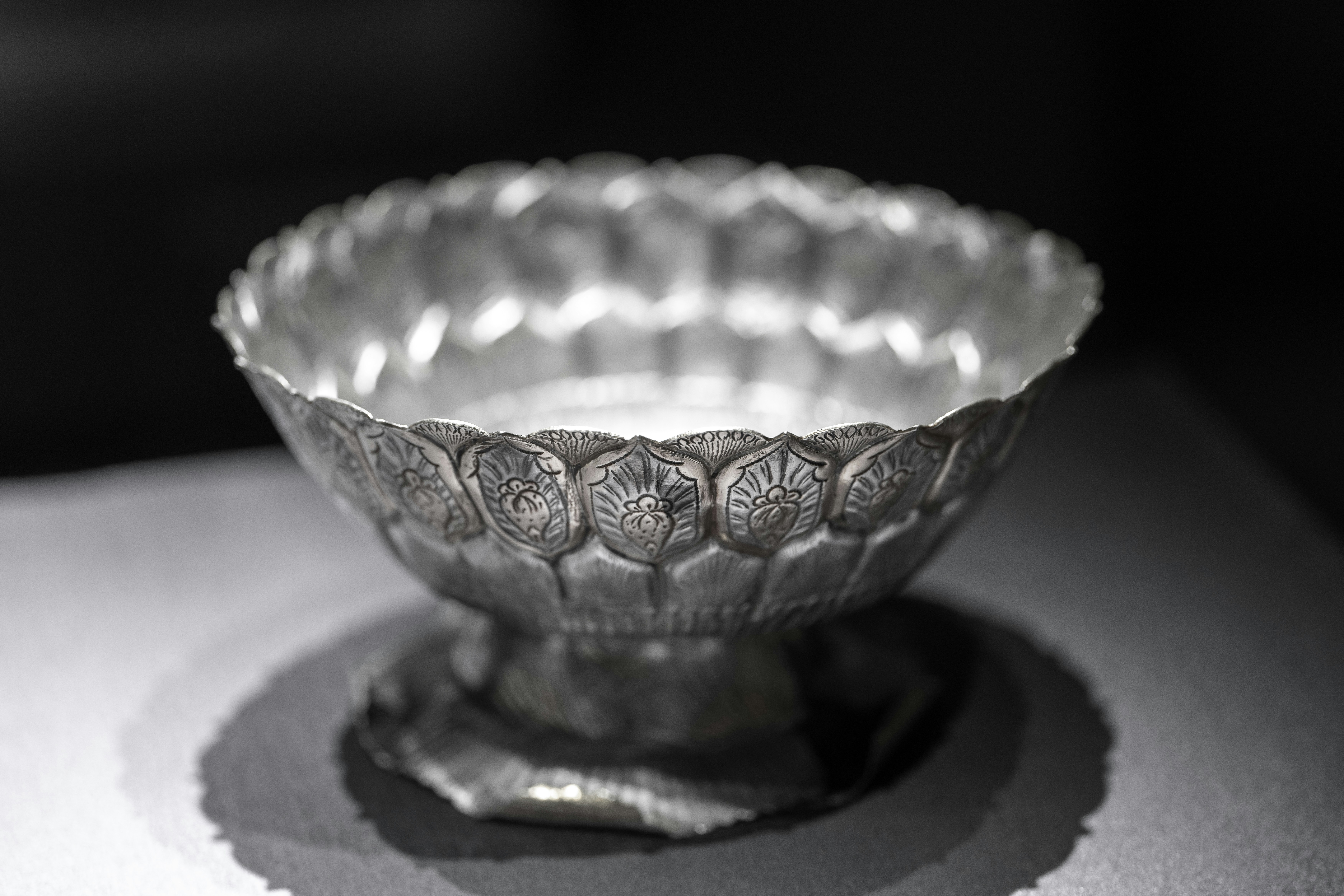 Silvery Petals: A Glass Bowl on a Soft Spotlight
