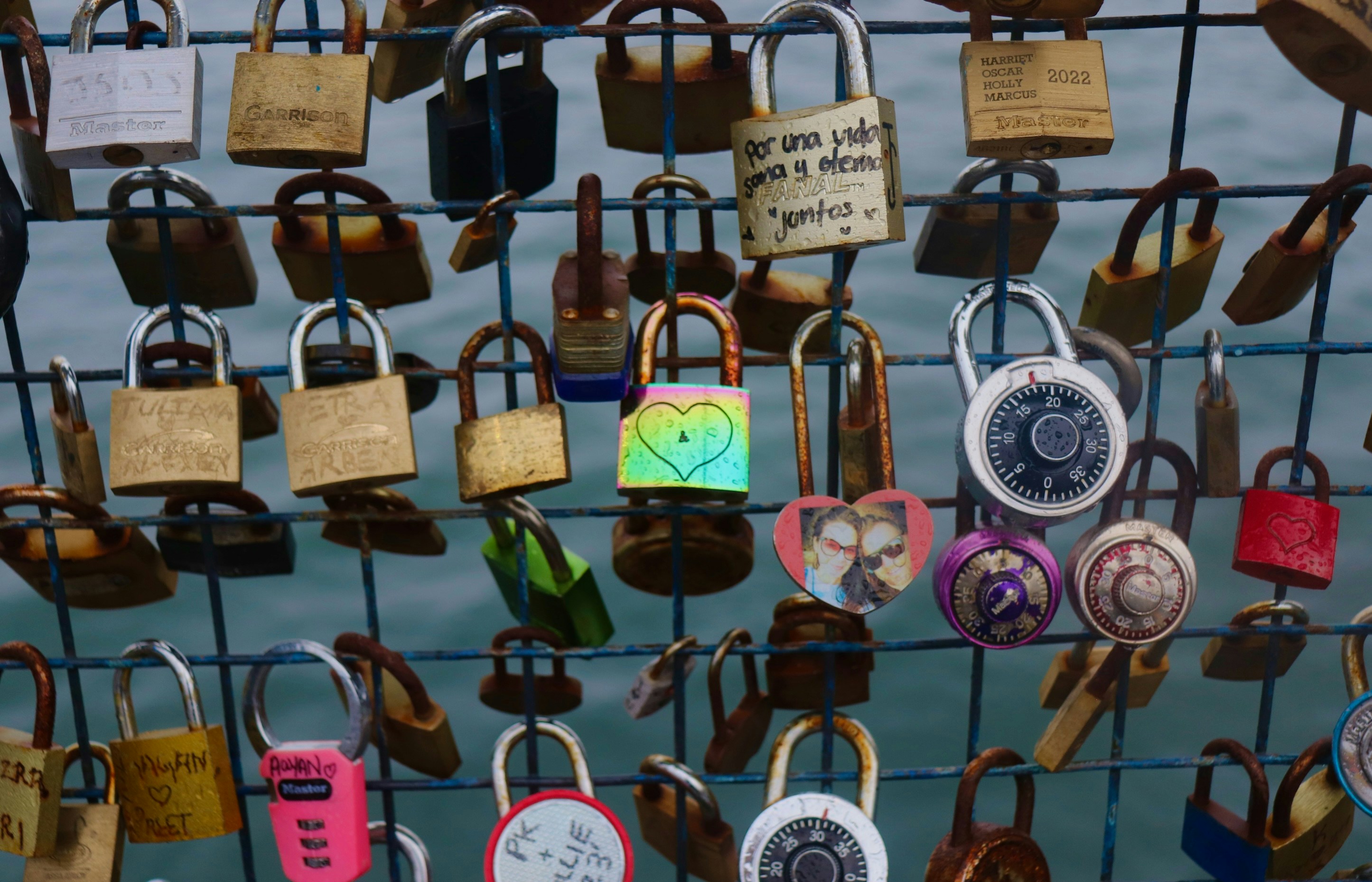 Iridescent Lock at the Center: a mosaic of love locks along a coastal railing